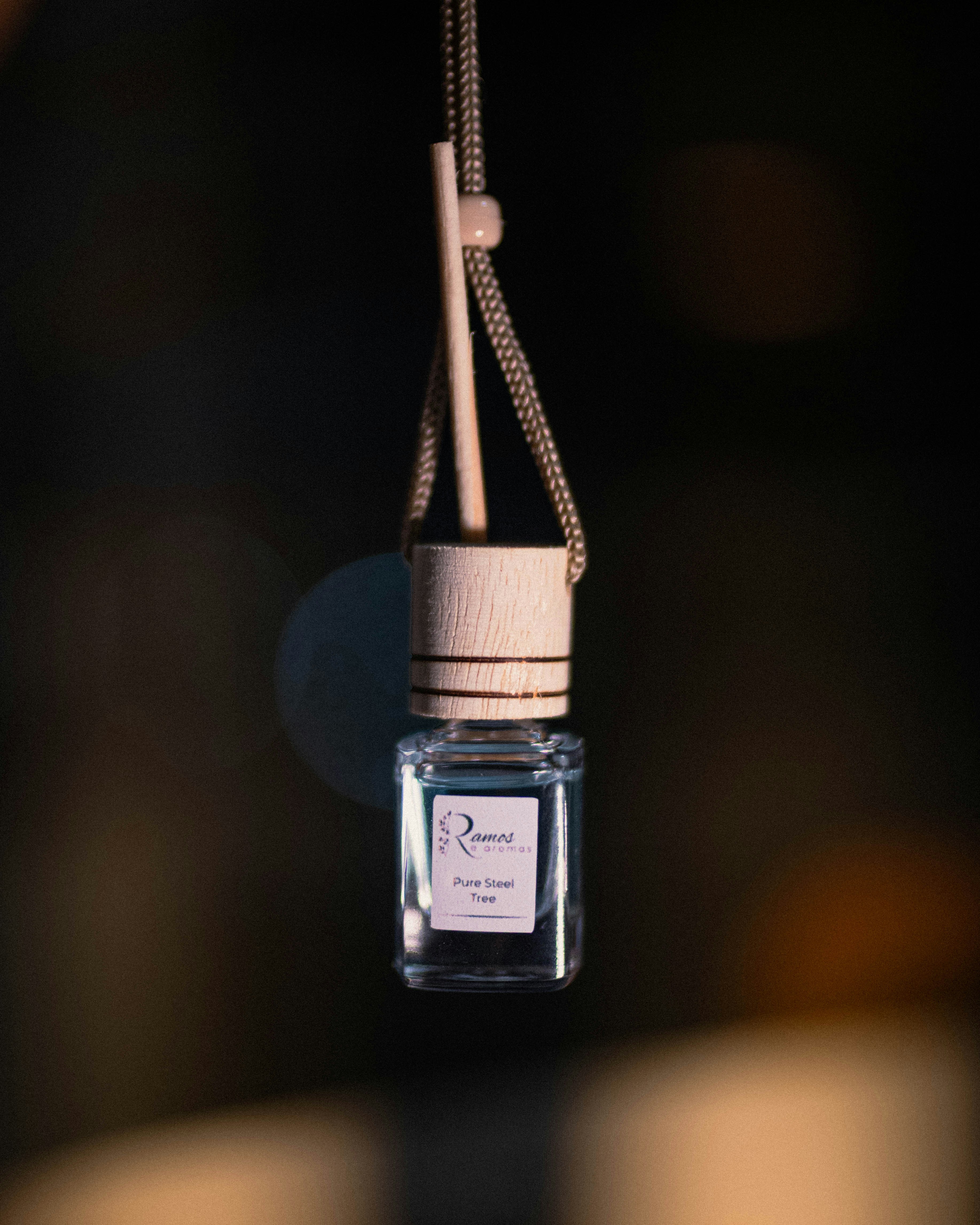 Hanging Pure Steel Tree: A Tiny Bottle Pendant in Soft Focus