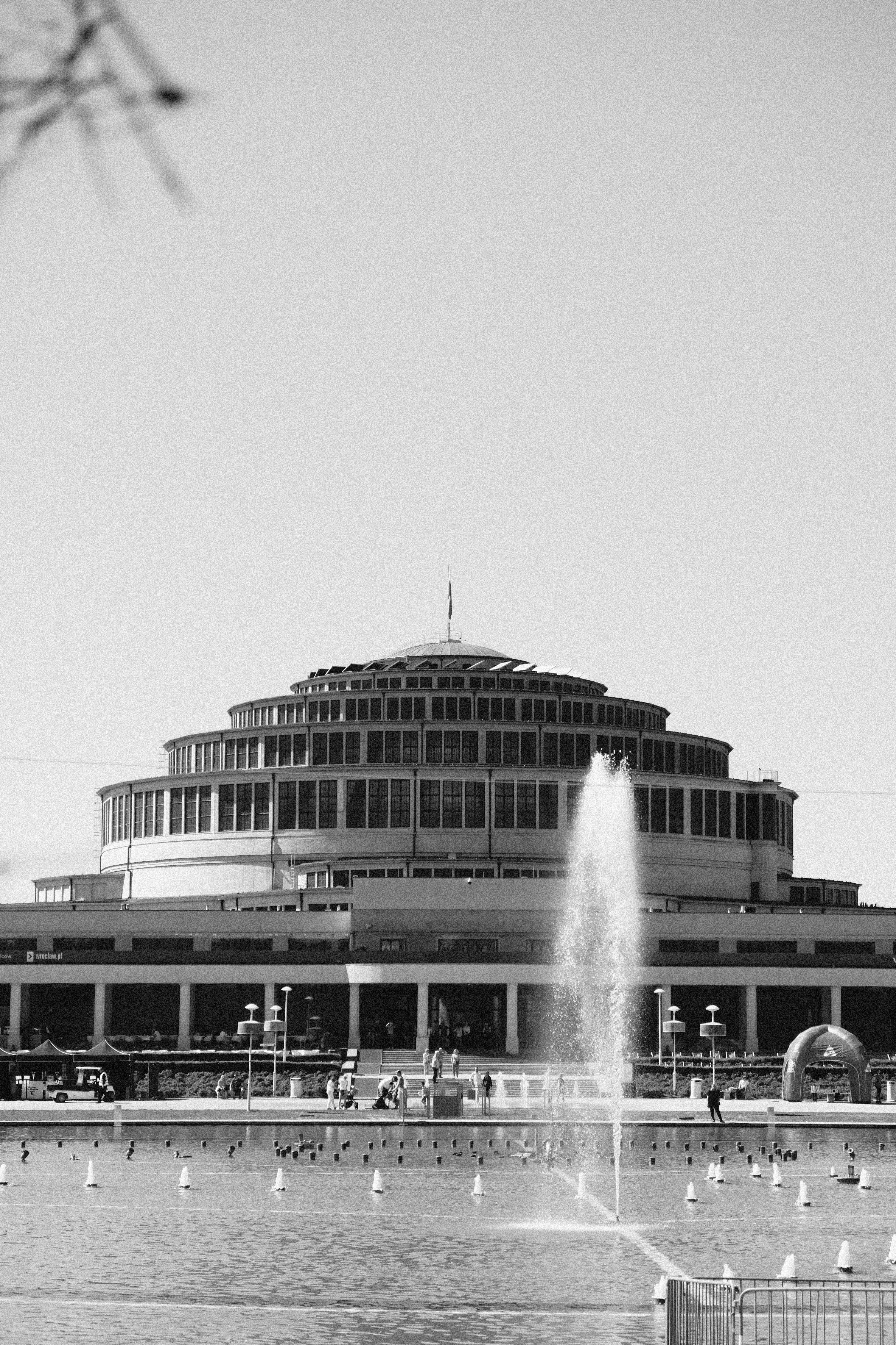 Circular Atrium Over Lake: A Quiet Monument Beneath a Water Spray