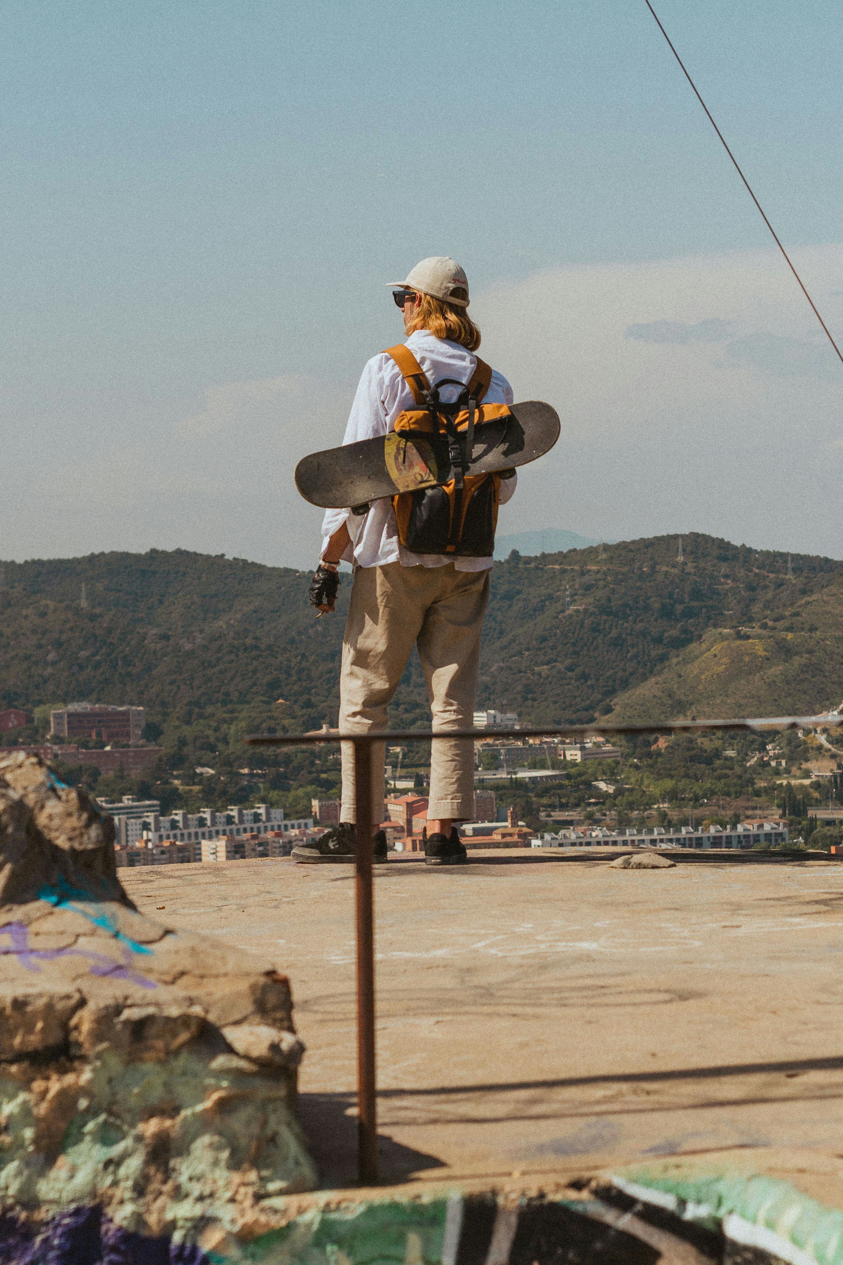 Skater at the Edge: Quiet Confidence Over a Rooftop Panorama