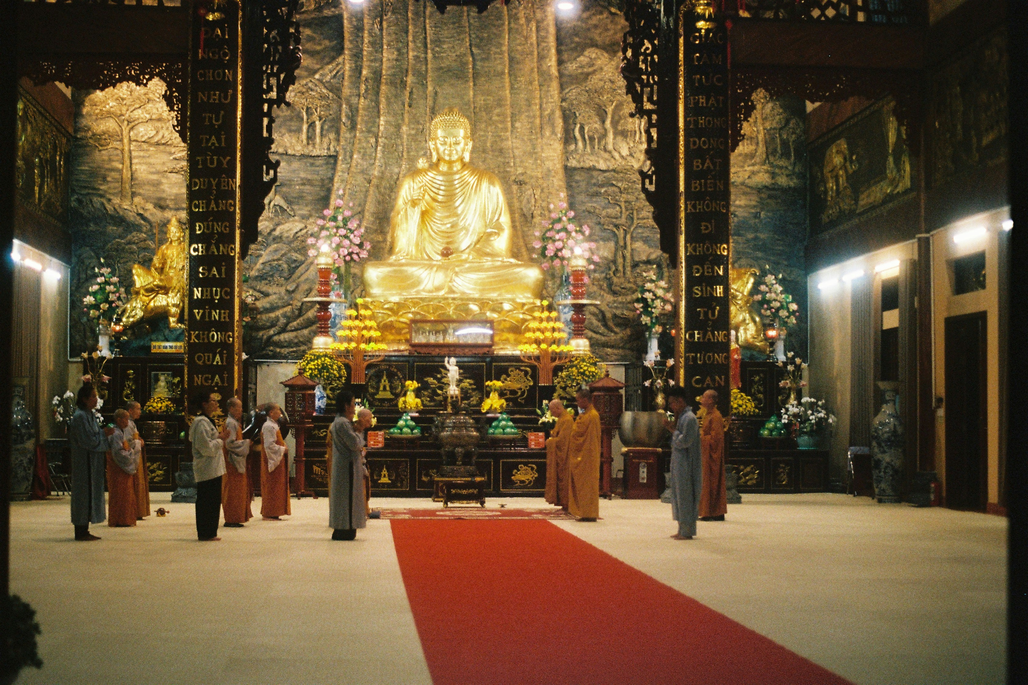 Golden Buddha, Quiet Procession: Devotion Inside a Temple Hall
