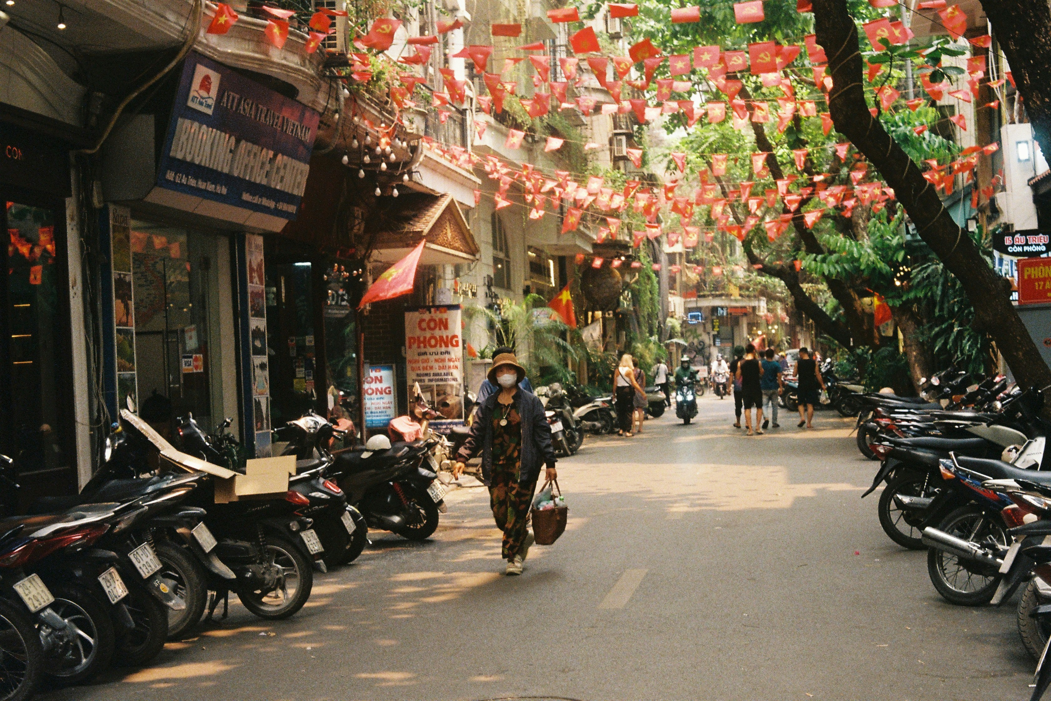 Lantern-lit Street Portrait: A Quiet Moment Amid Bustling Hanoi