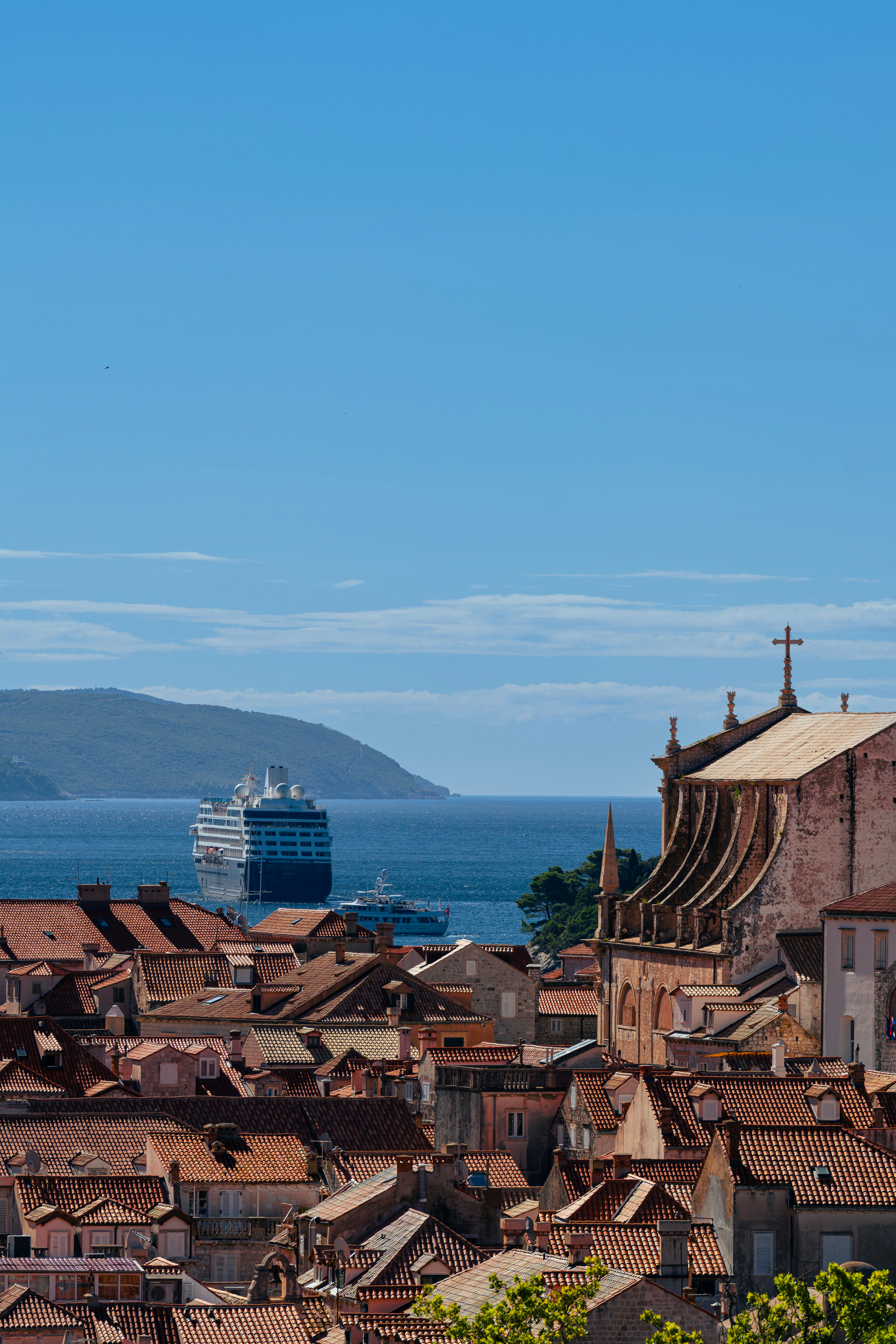 Harbor Edge: Rooftops, Sea, and a Distant Cruise