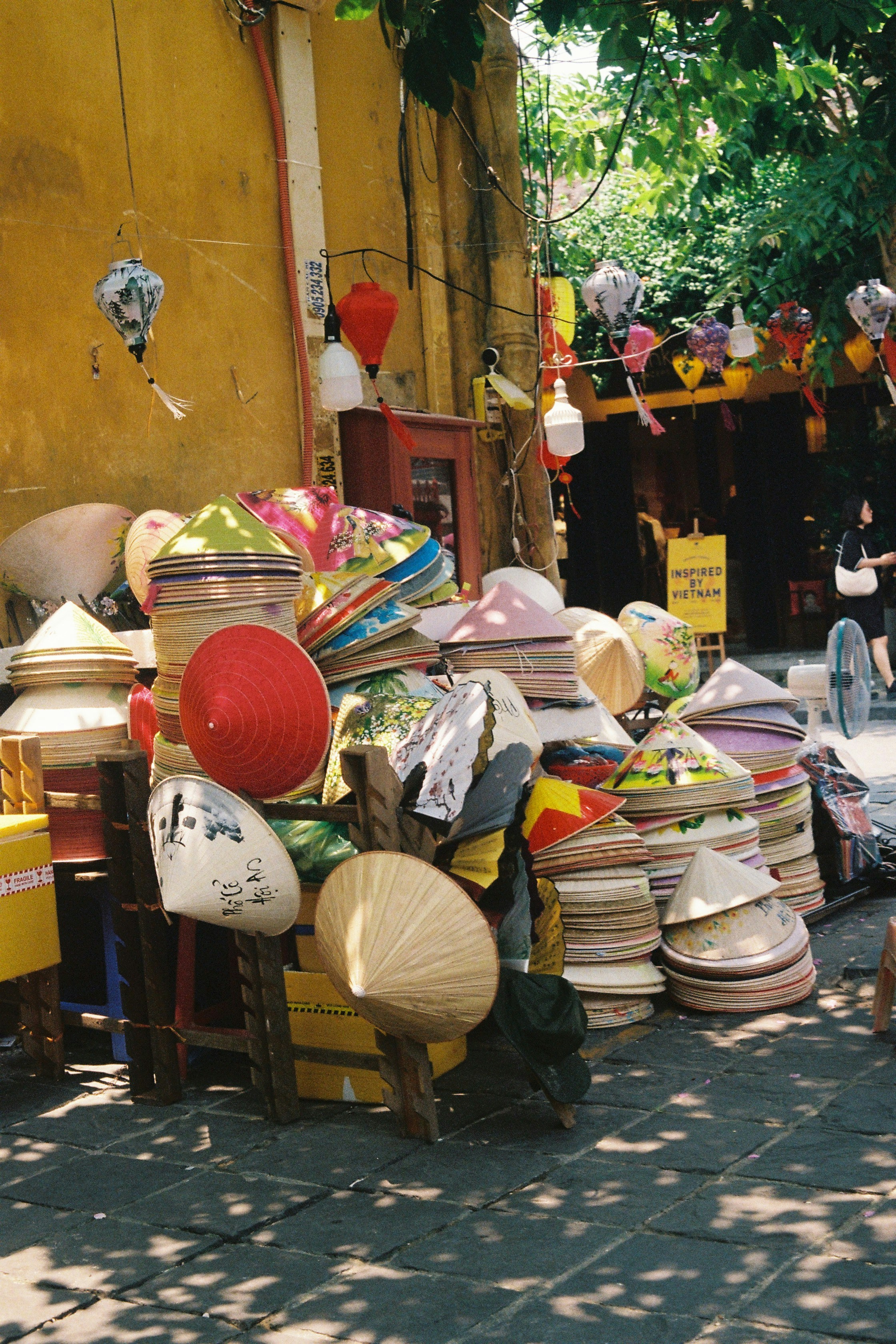 Colorful Conical Hats Parade on a Sunlit Alley