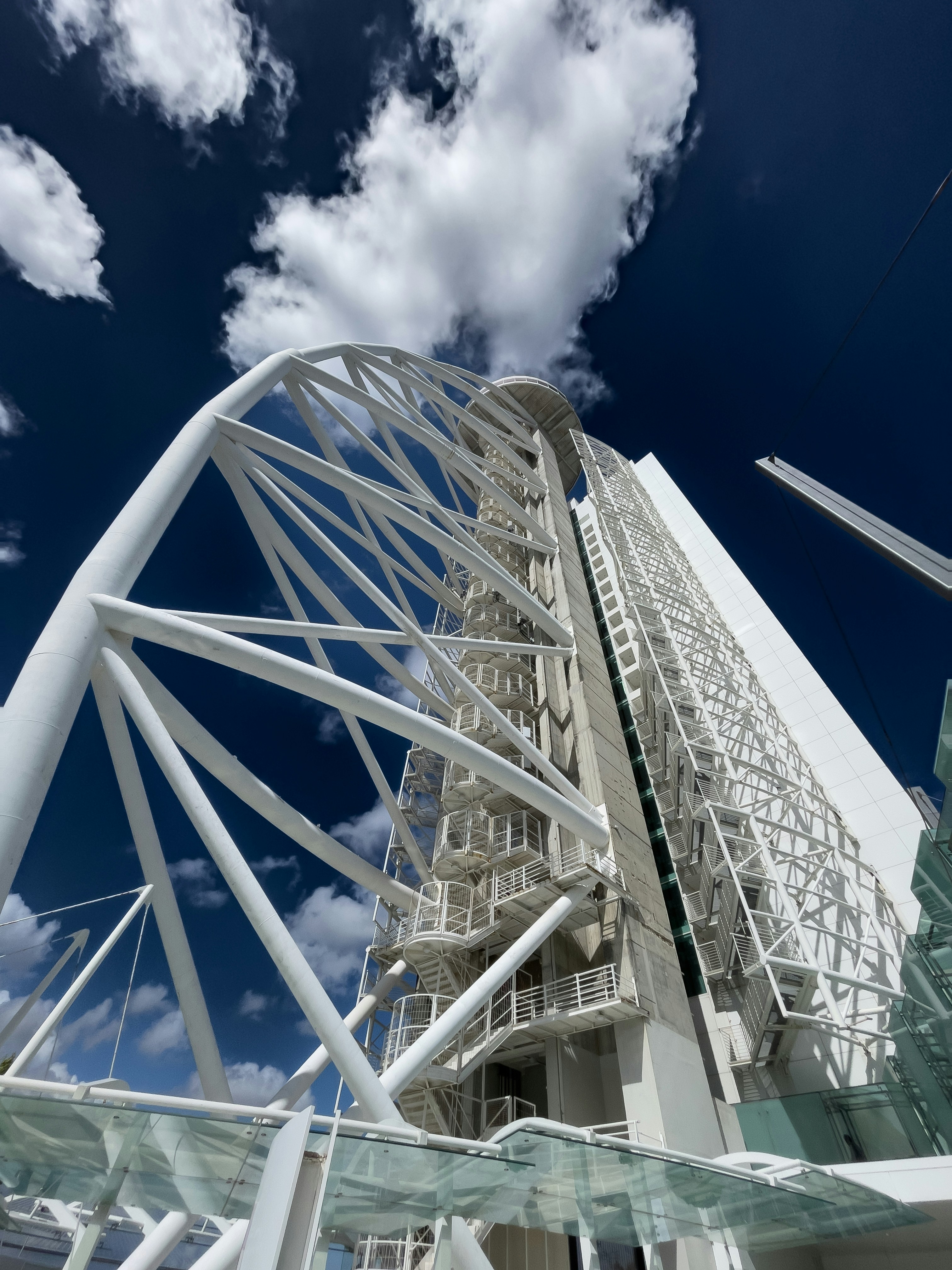 Skeletal Arc: The Striated Tower Against a Velvet Sky