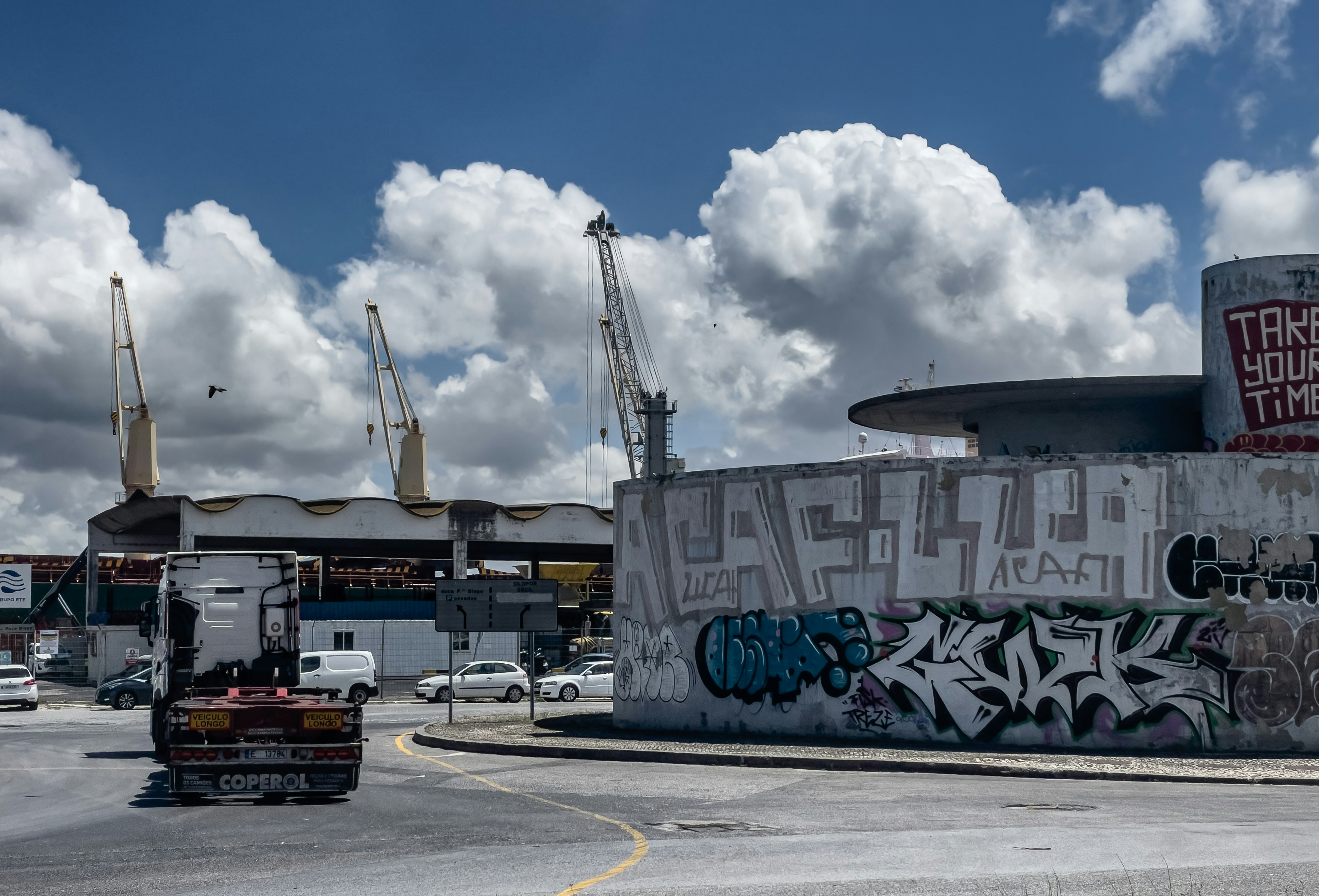 Harborfront Graffiti Circles the Crane-filled Skyline