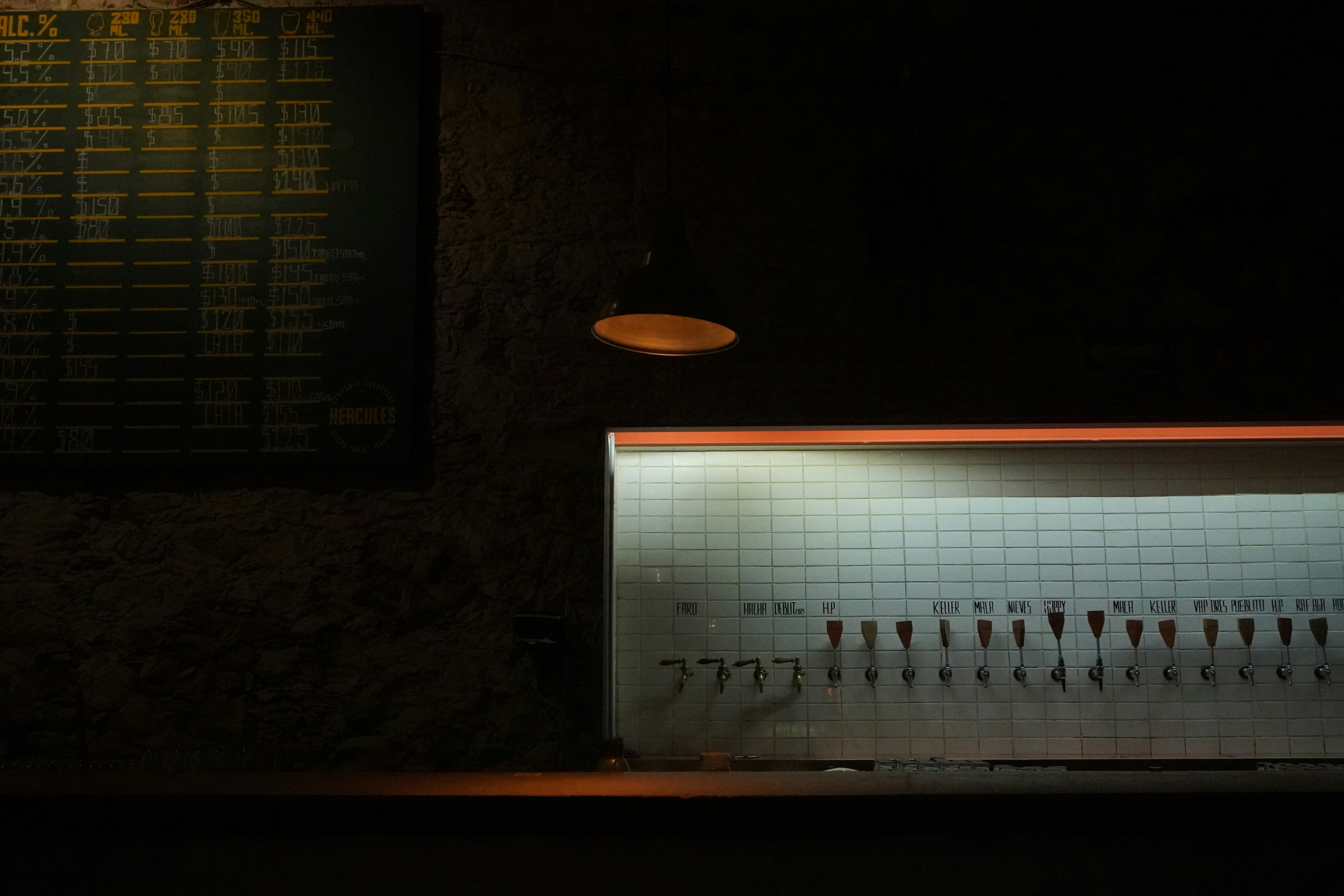 Dim Taproom Neon and Dotted Taps in Quiet Night