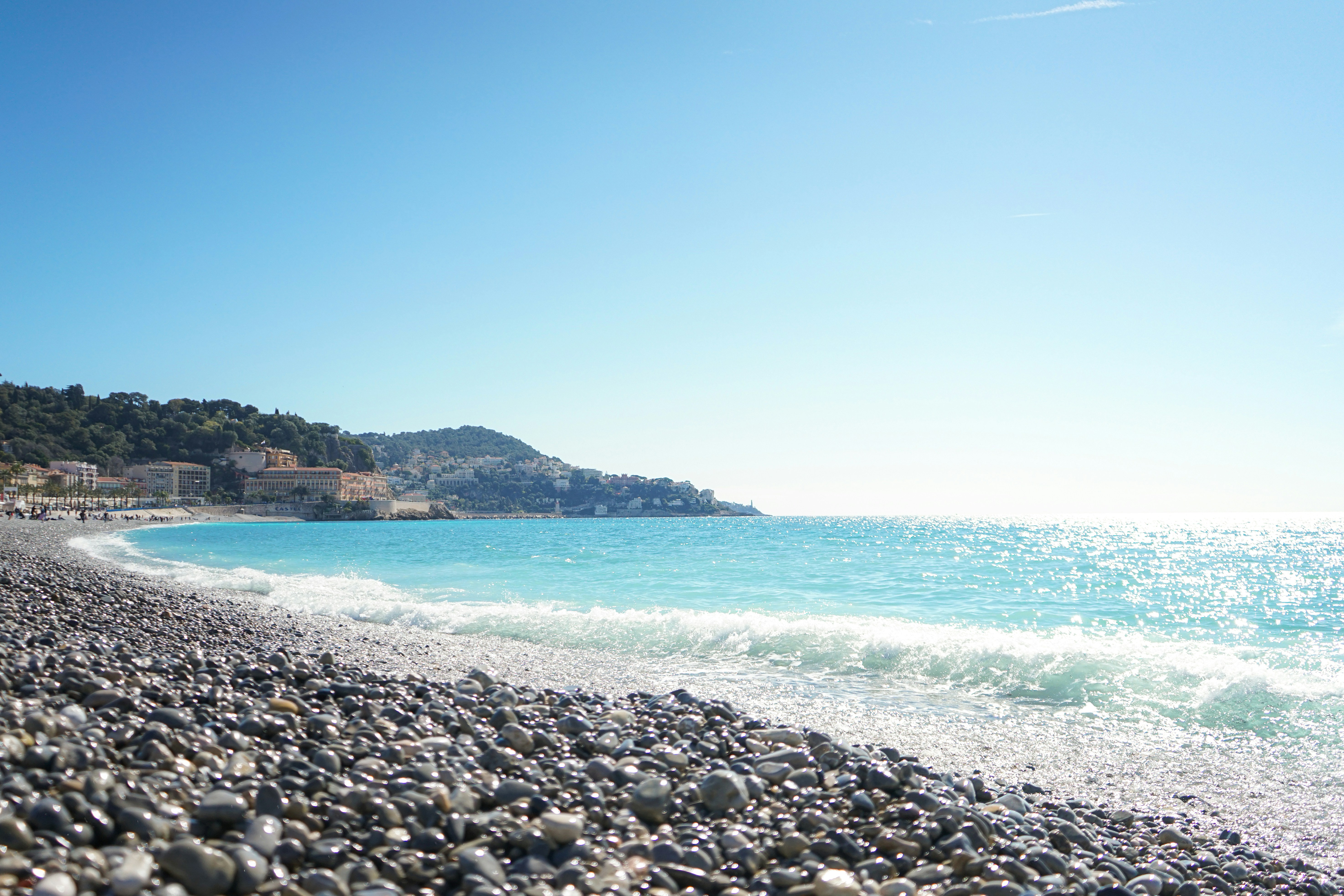 Pebble Beach Horizon: Shimmering Sea and Quiet shoreline