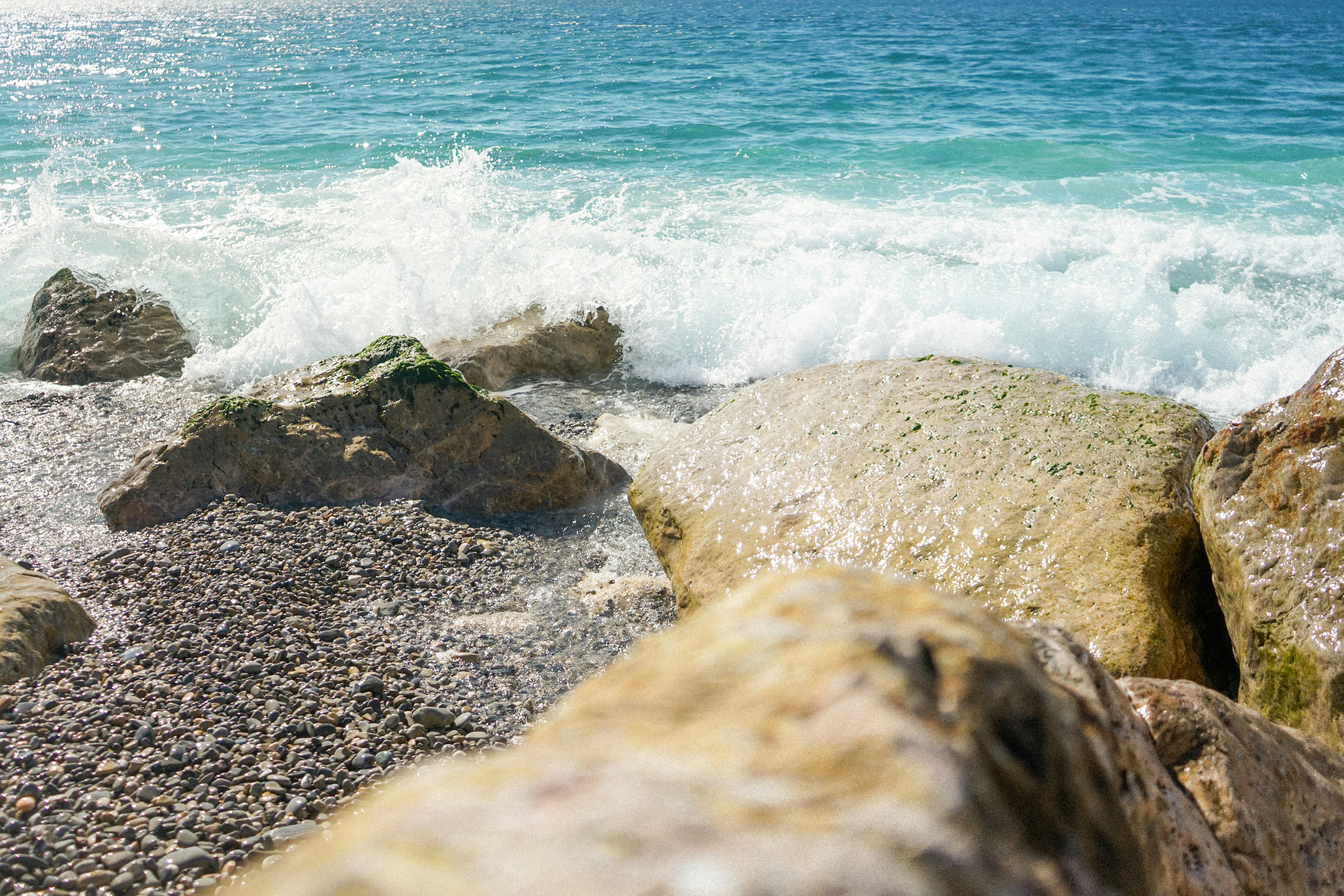 Rugged Seaside Crest: Stones Meet Ocean Foam