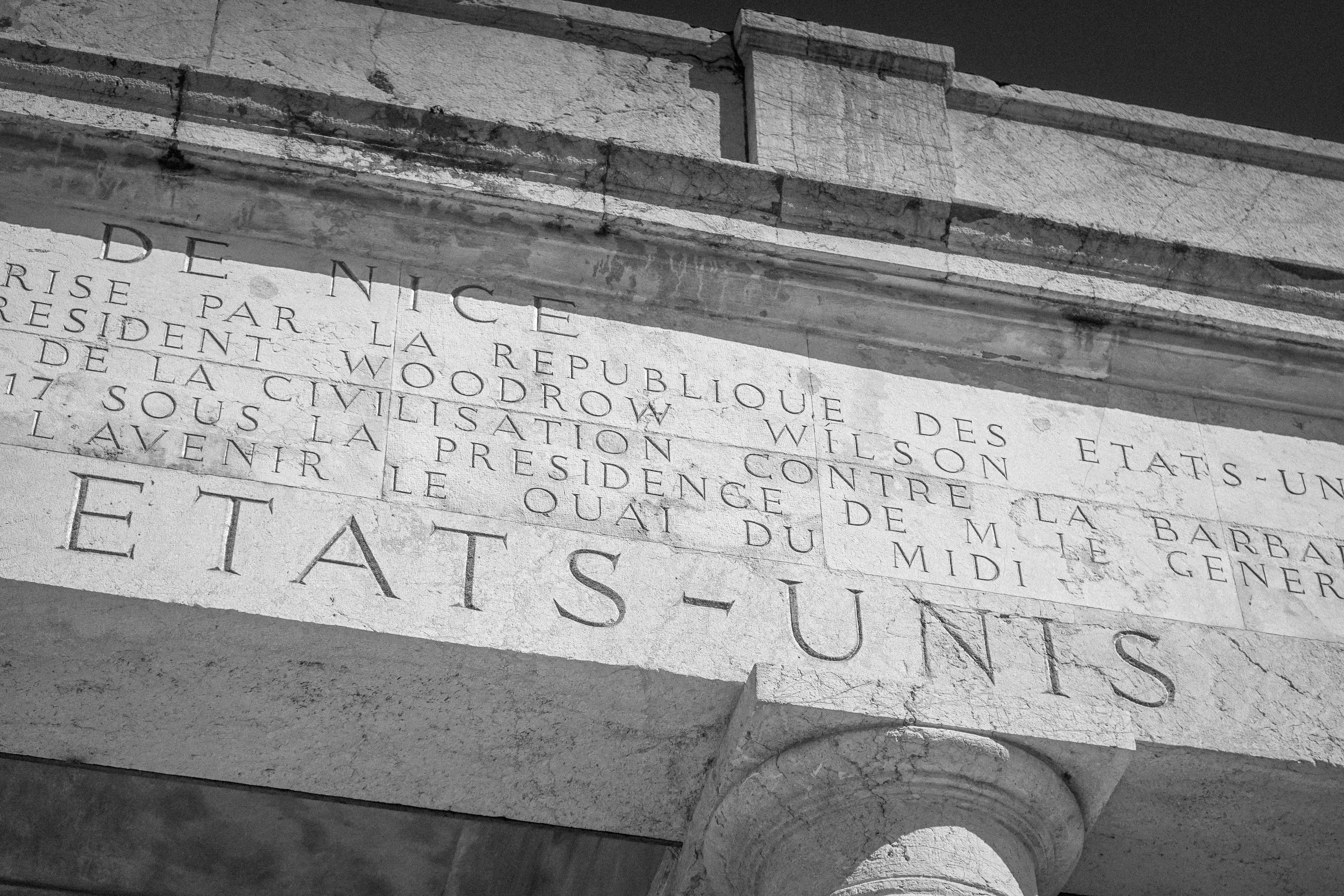Stone Archways and Inscribed Facade in Sunlit Frieze