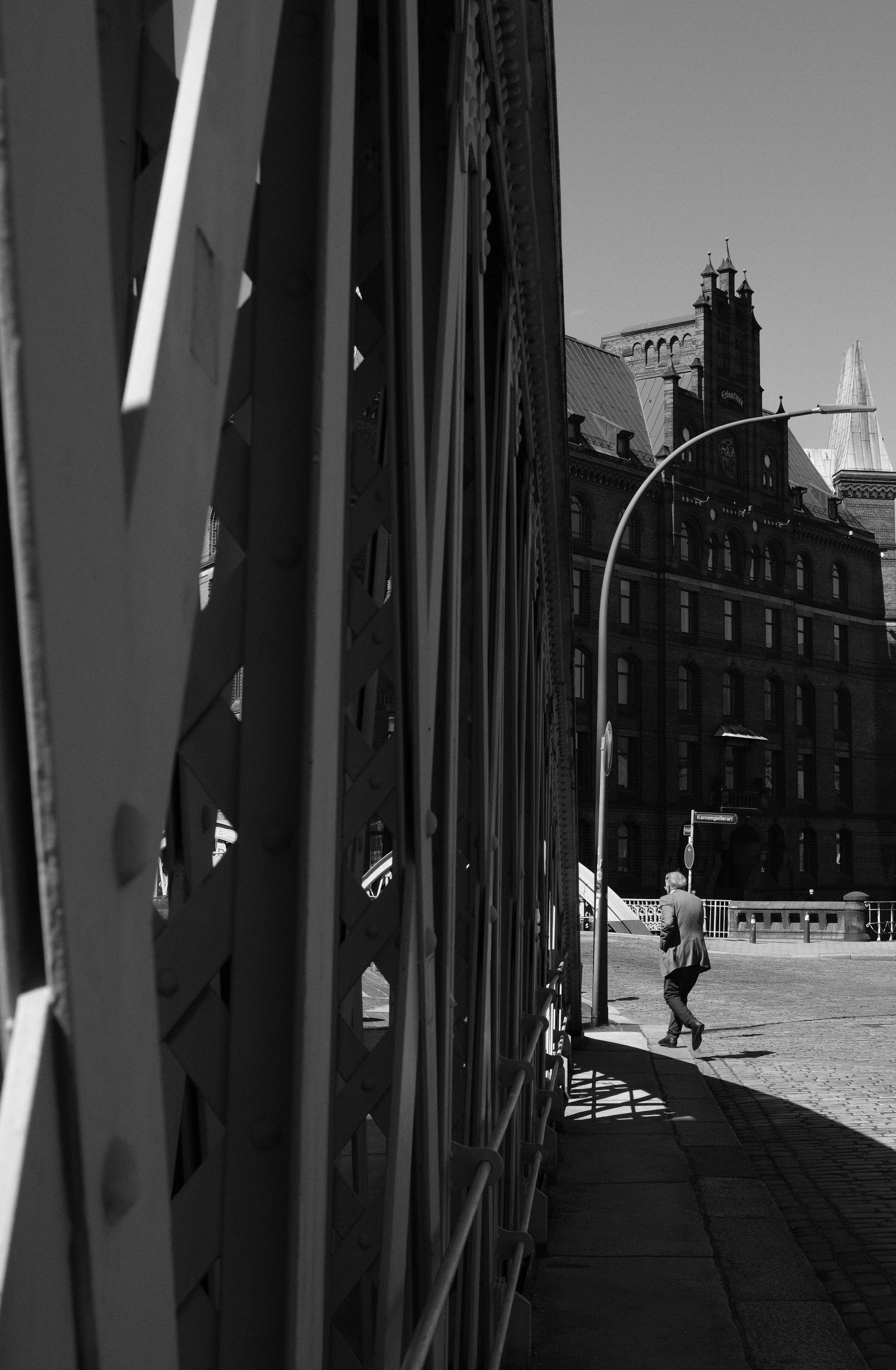 Steel Truss Convergence: A Pedestrian Crossing the Historic Bridge