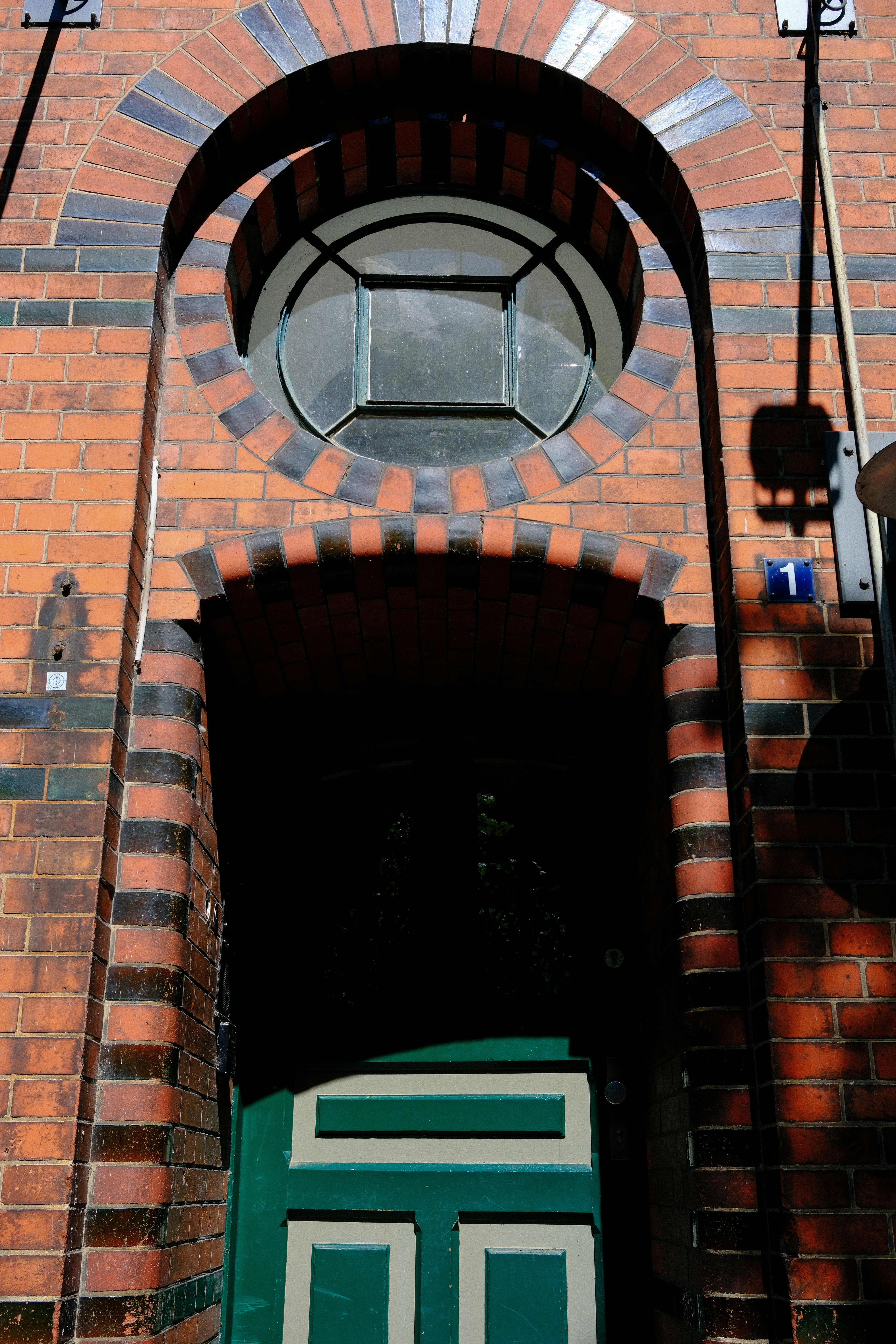 Green Door Beneath a Brick Archway