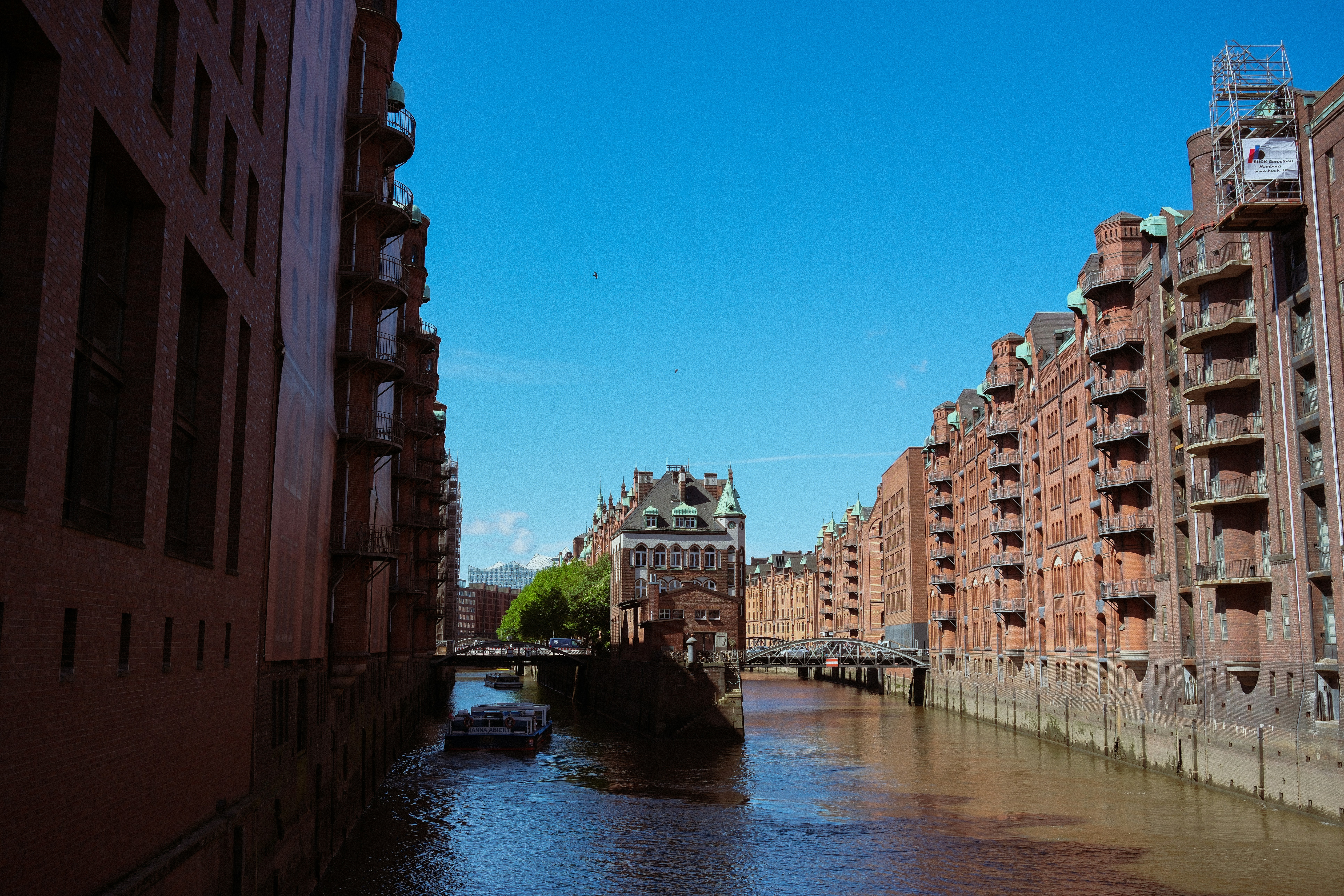 Canal between brick buildings with a boat