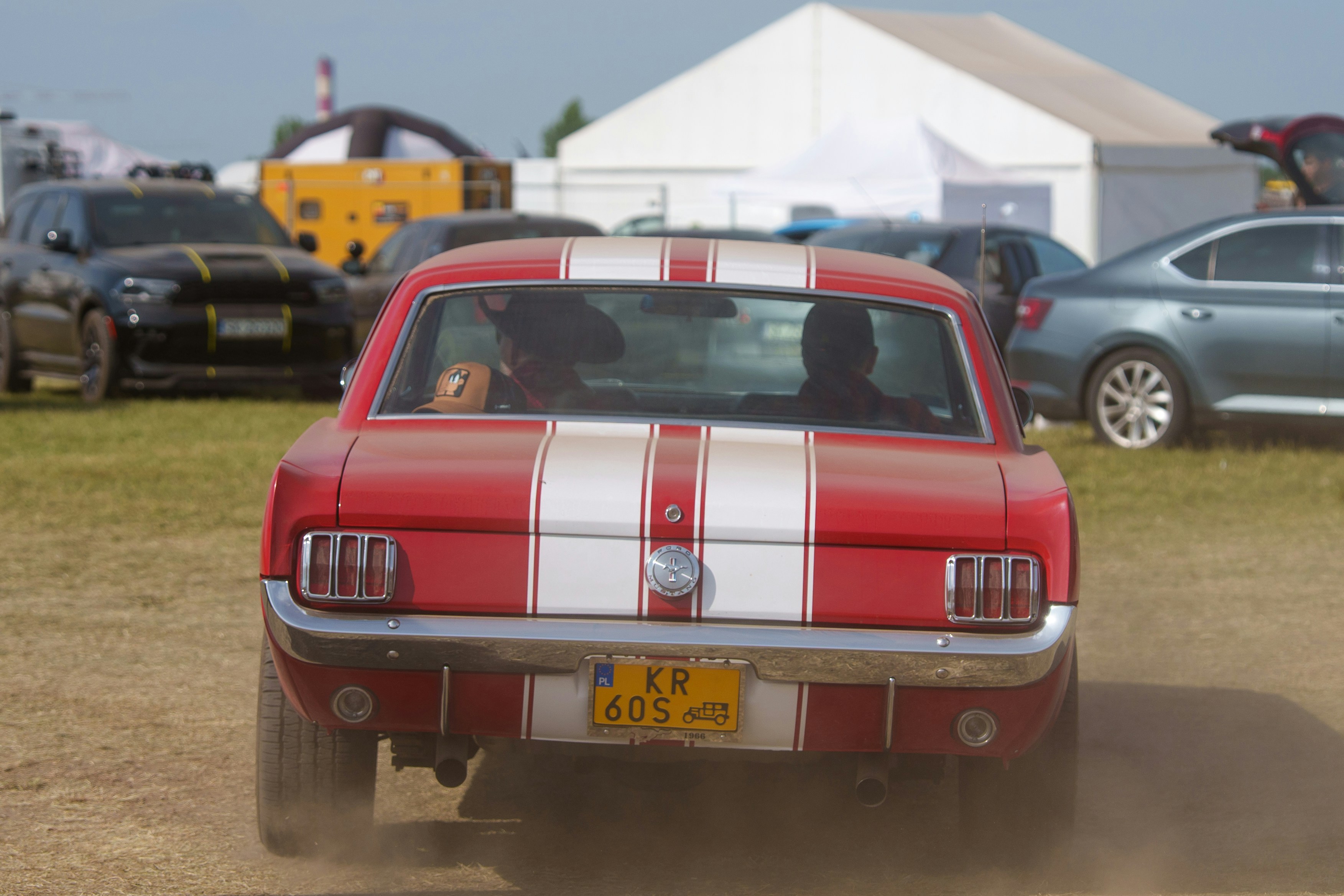 Red Muscle Car in a Dirt-Pilled Showground Backdrop