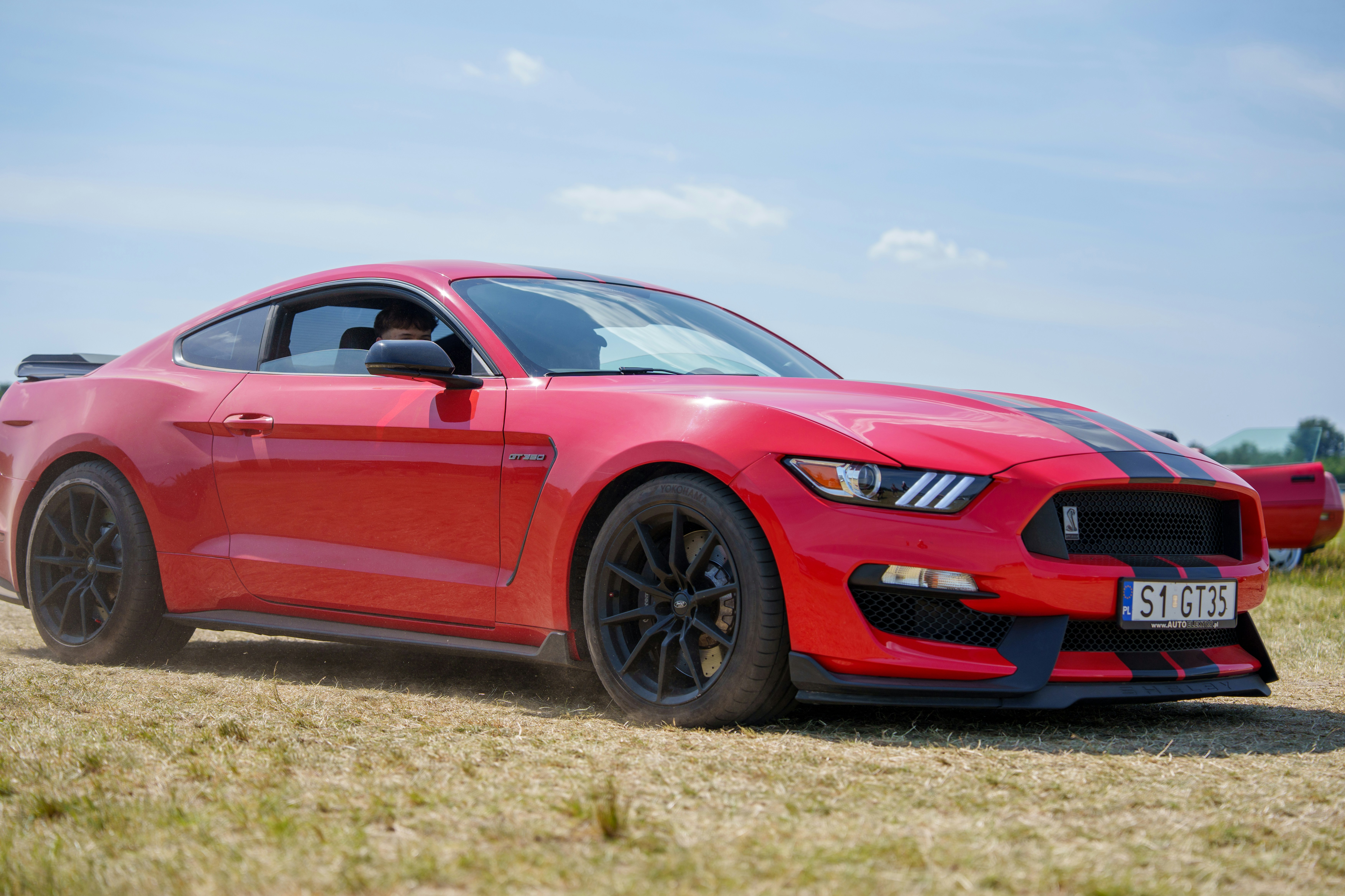Red Thunder: A Mustang on a Dusty Stretch
