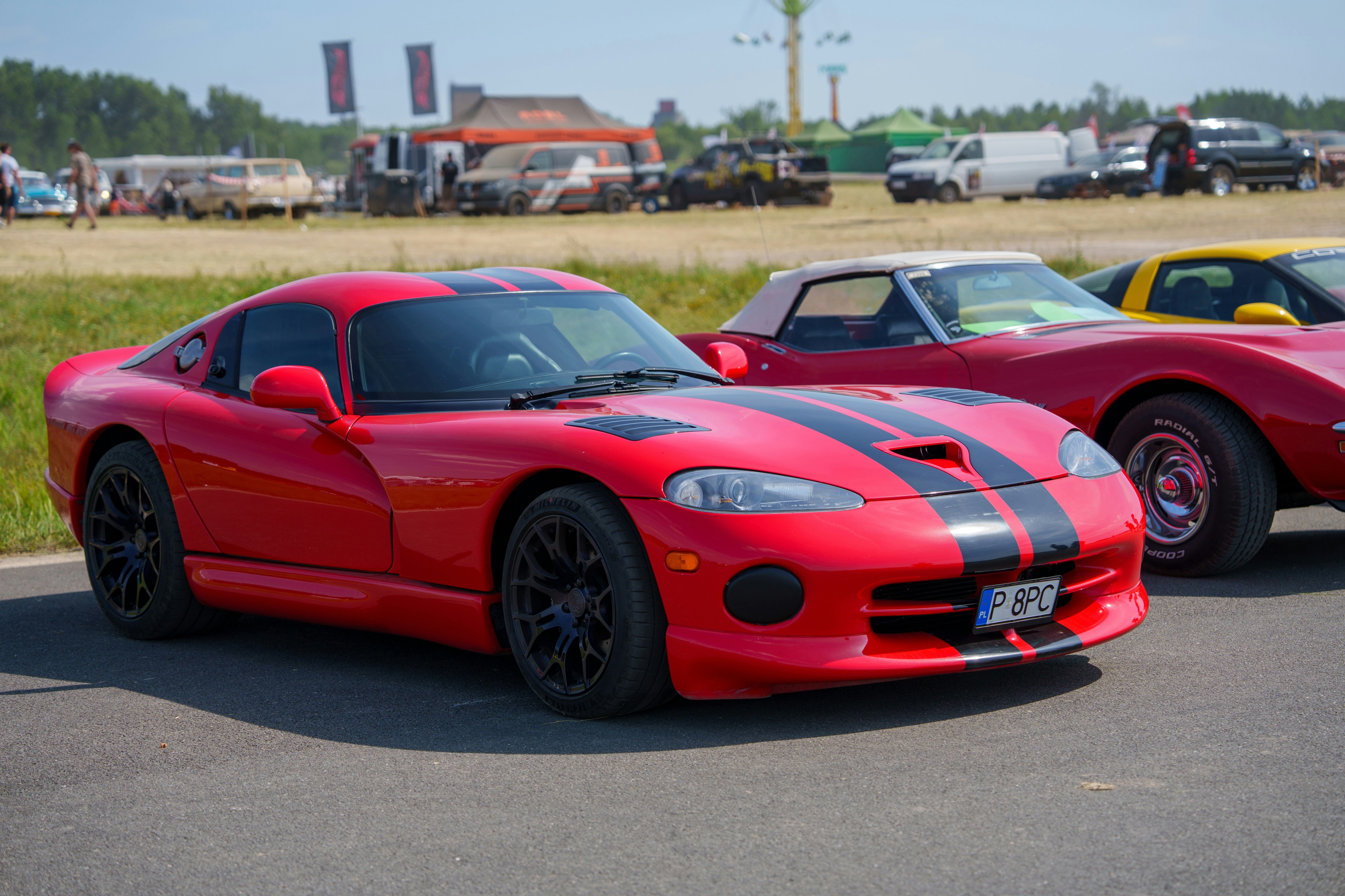 Red Dodge Viper Gliding Across a Car Show Stage
