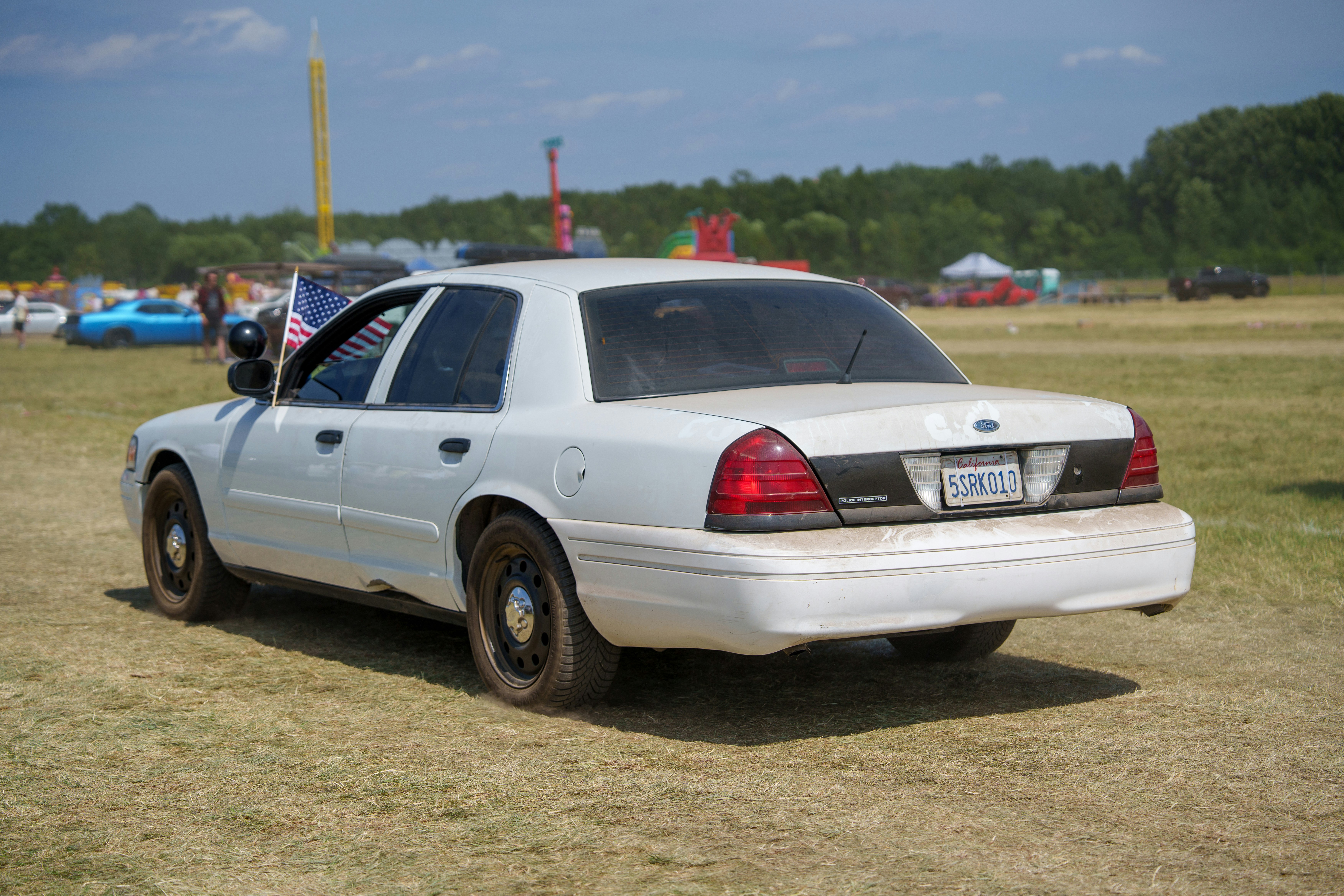 Patriotic sedan at a sunlit car show