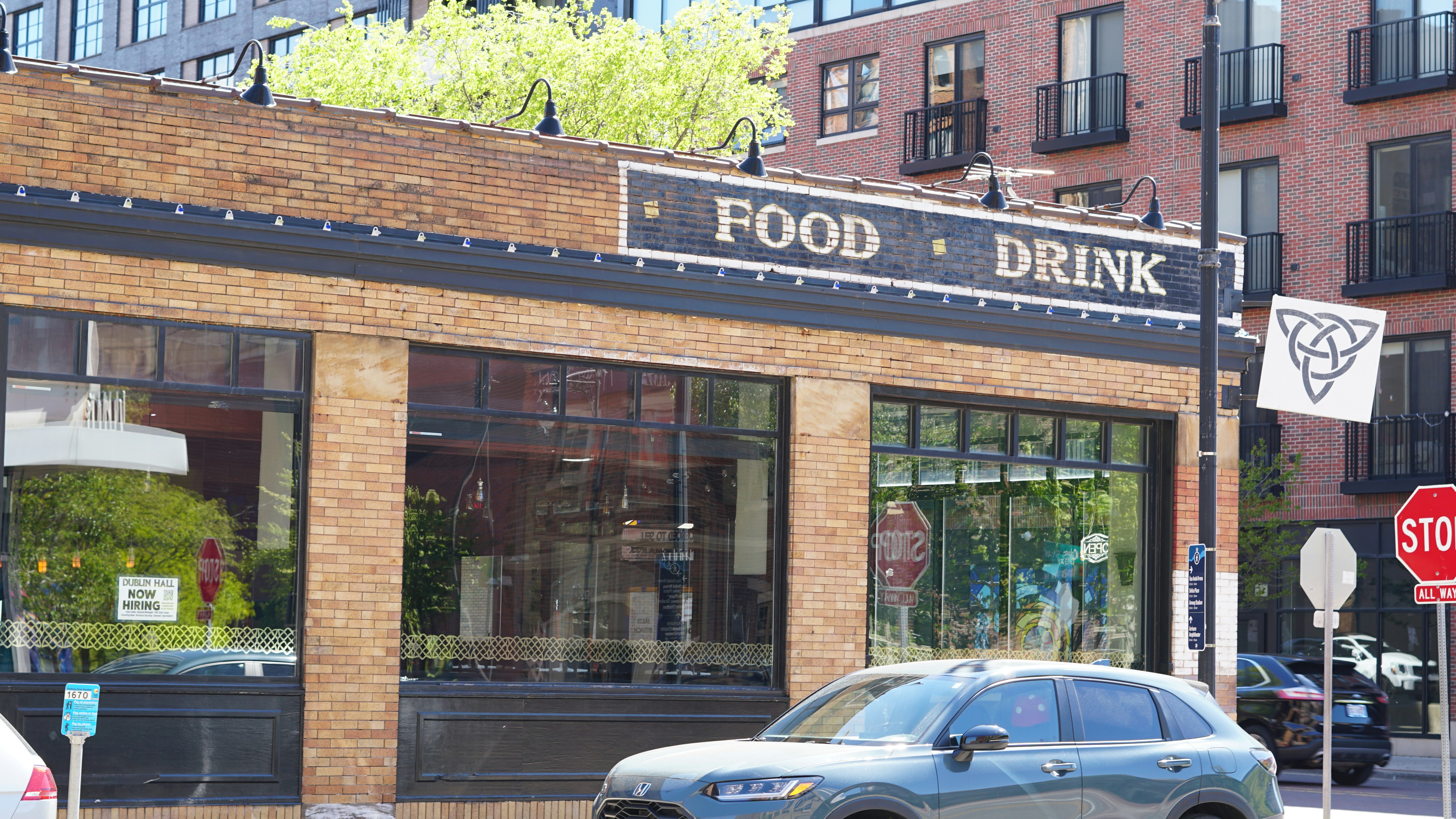 Brick Facade Bistro Under Glass: A Street Scene by the Drive