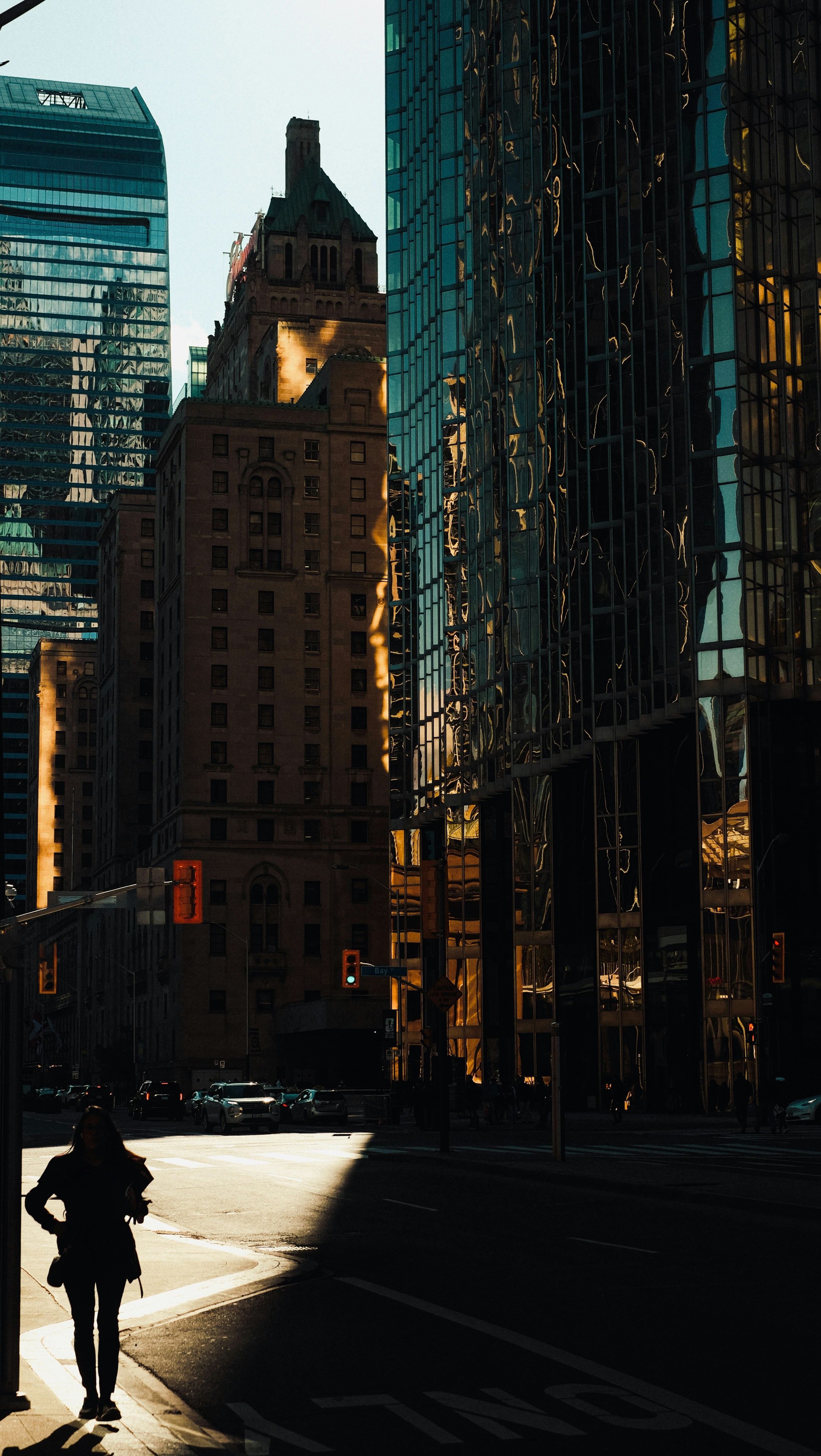Shadowed Pedestrian Walkway Between Glass and Brick