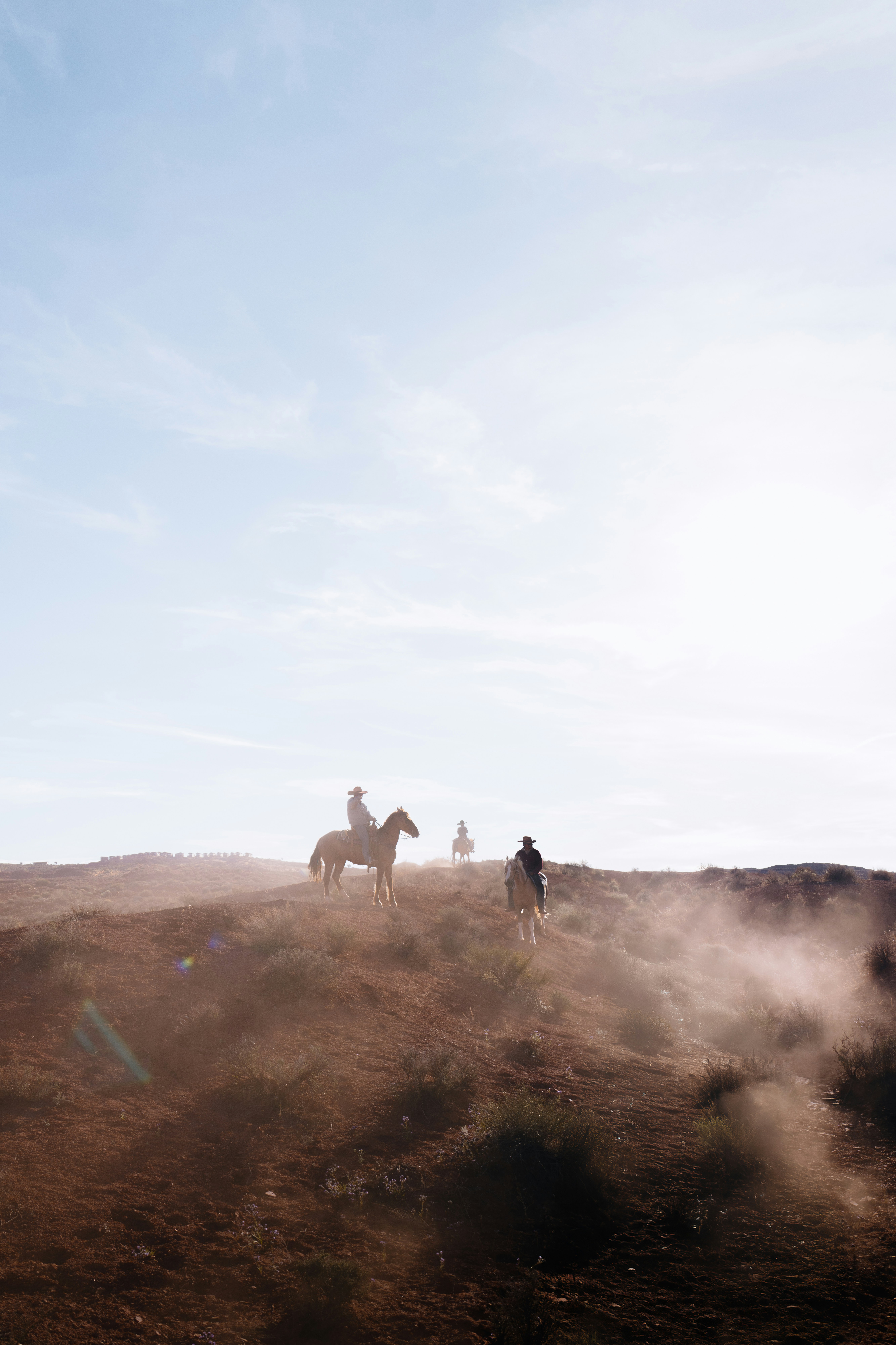Dust and Dust: Riders on the Hill at Dusk