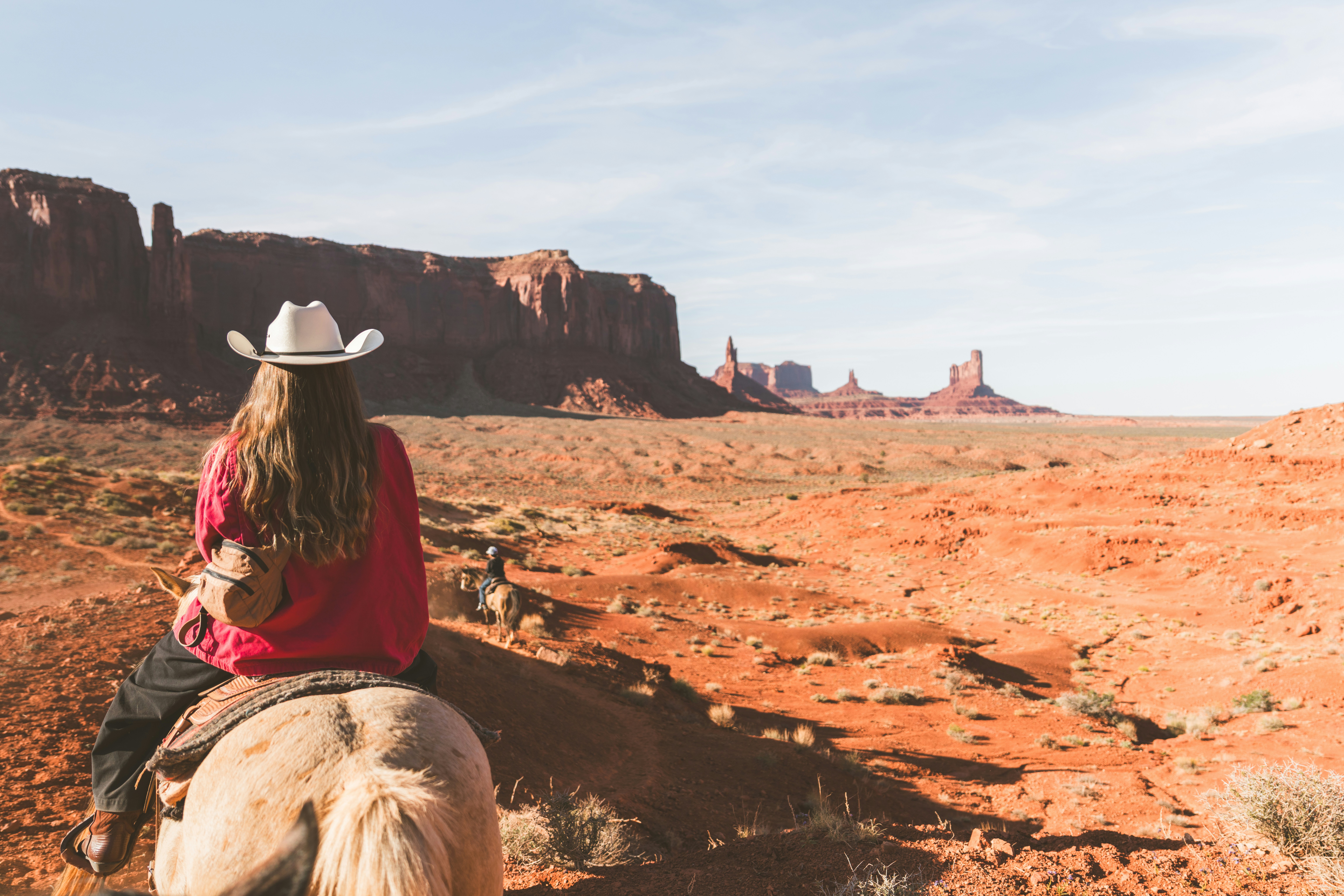 Desert Trail: Rider in a Red Jacket Gazing Toward Monument Valley Horizon