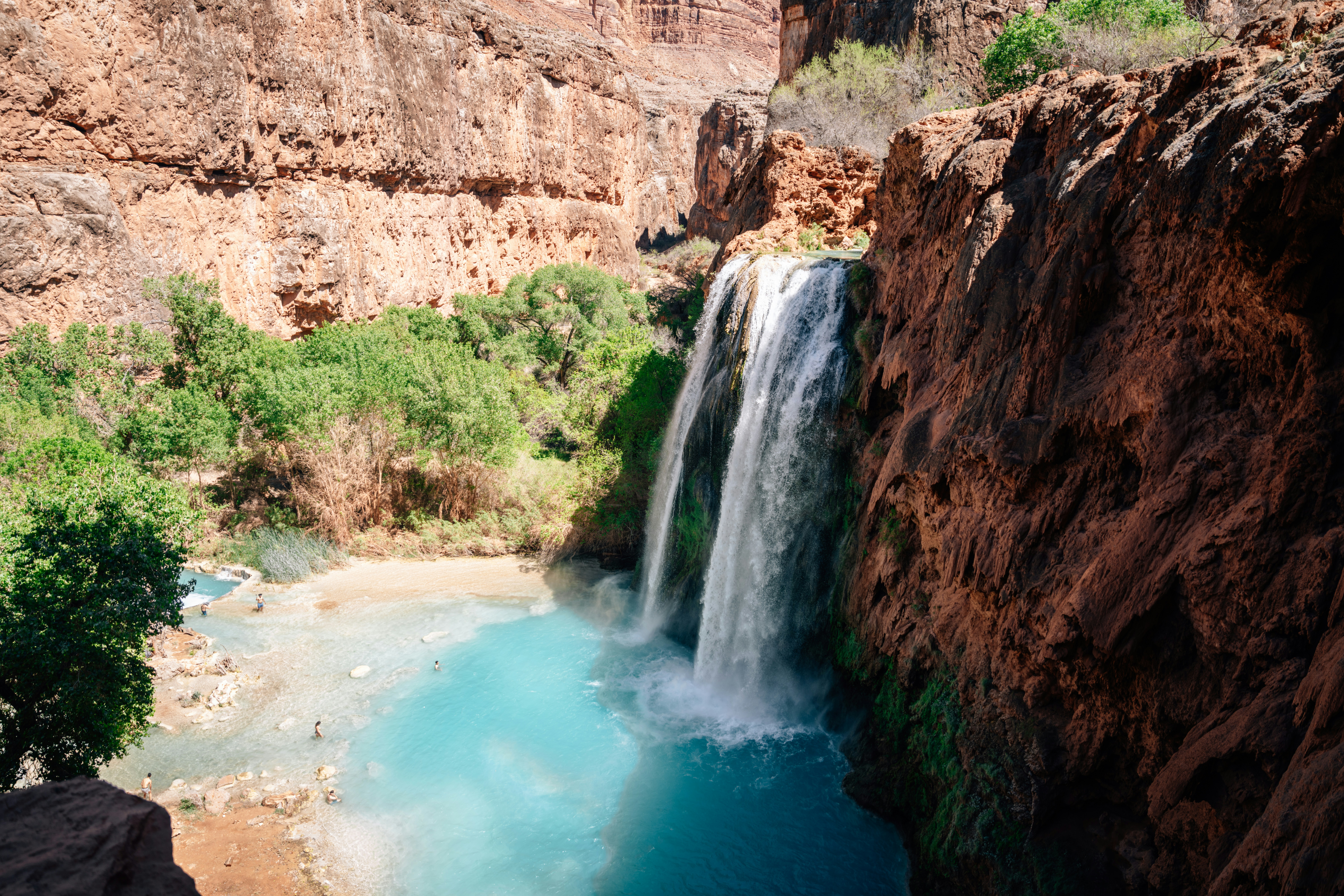 Turquoise Veil: A Canyon Waterfall Between Amber Cliffs