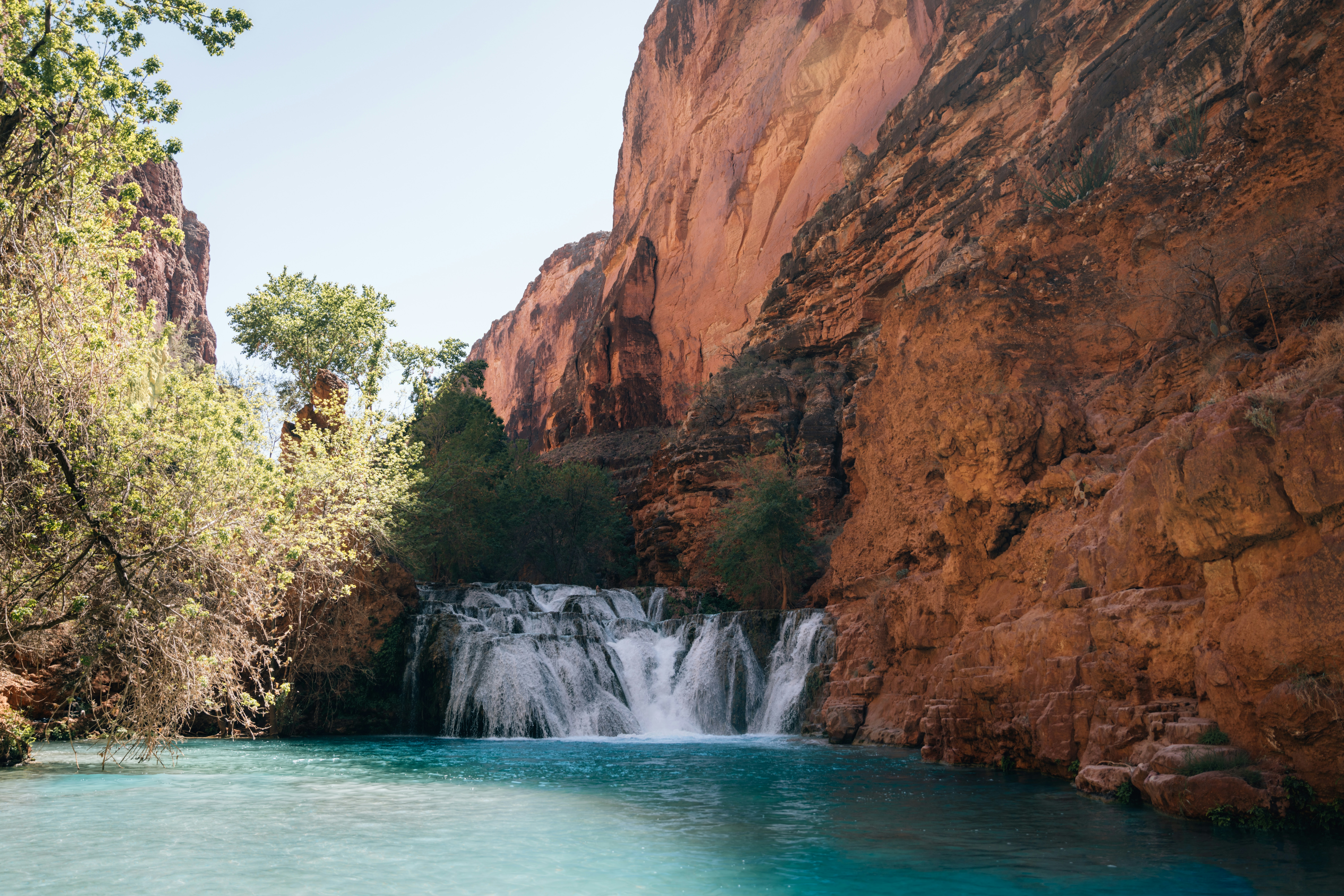 Emerald Pool Cascade Between Sunlit Canyon Walls