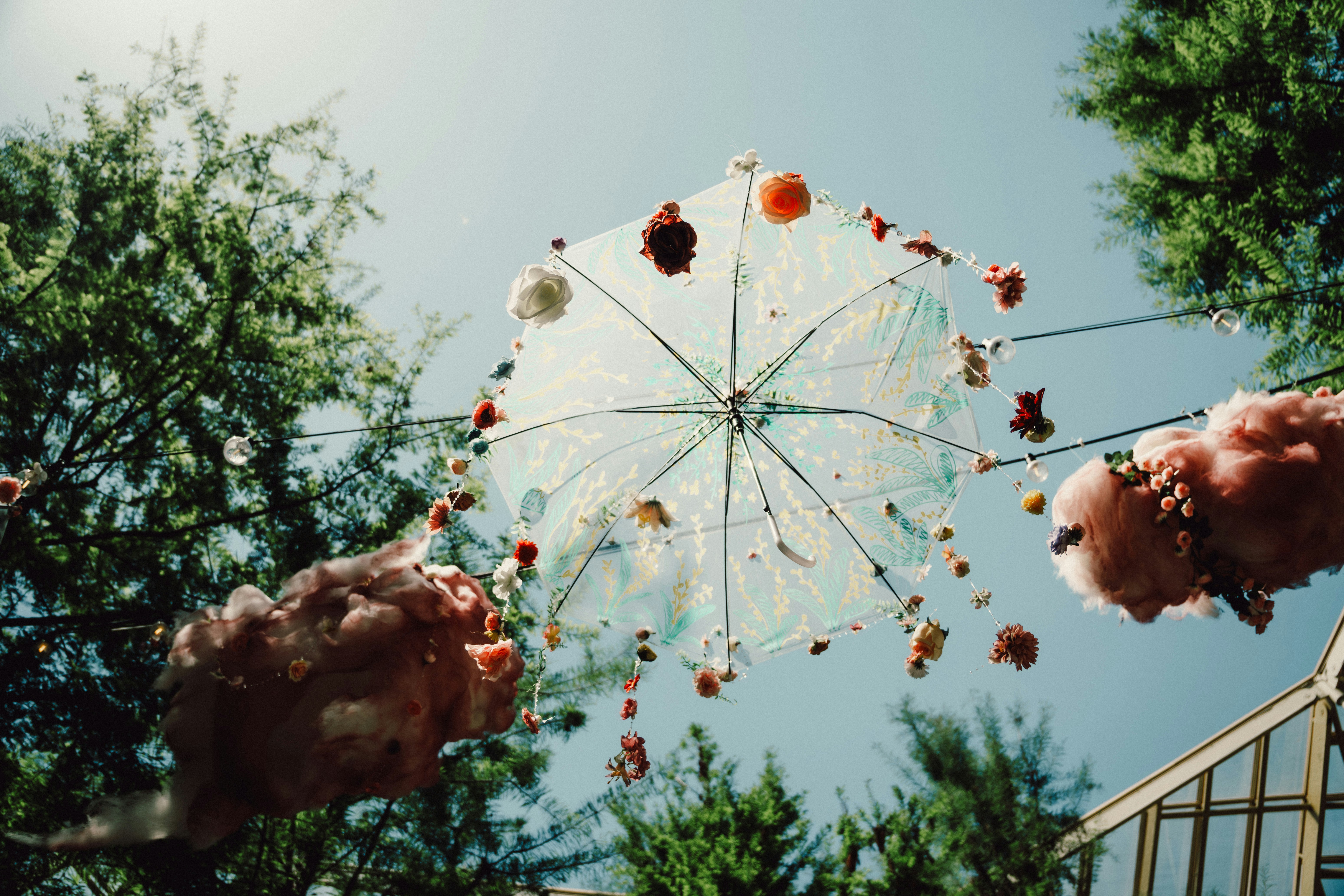 Suspended Bloom: A Kite-like Wheel of Flowers Against the Sky