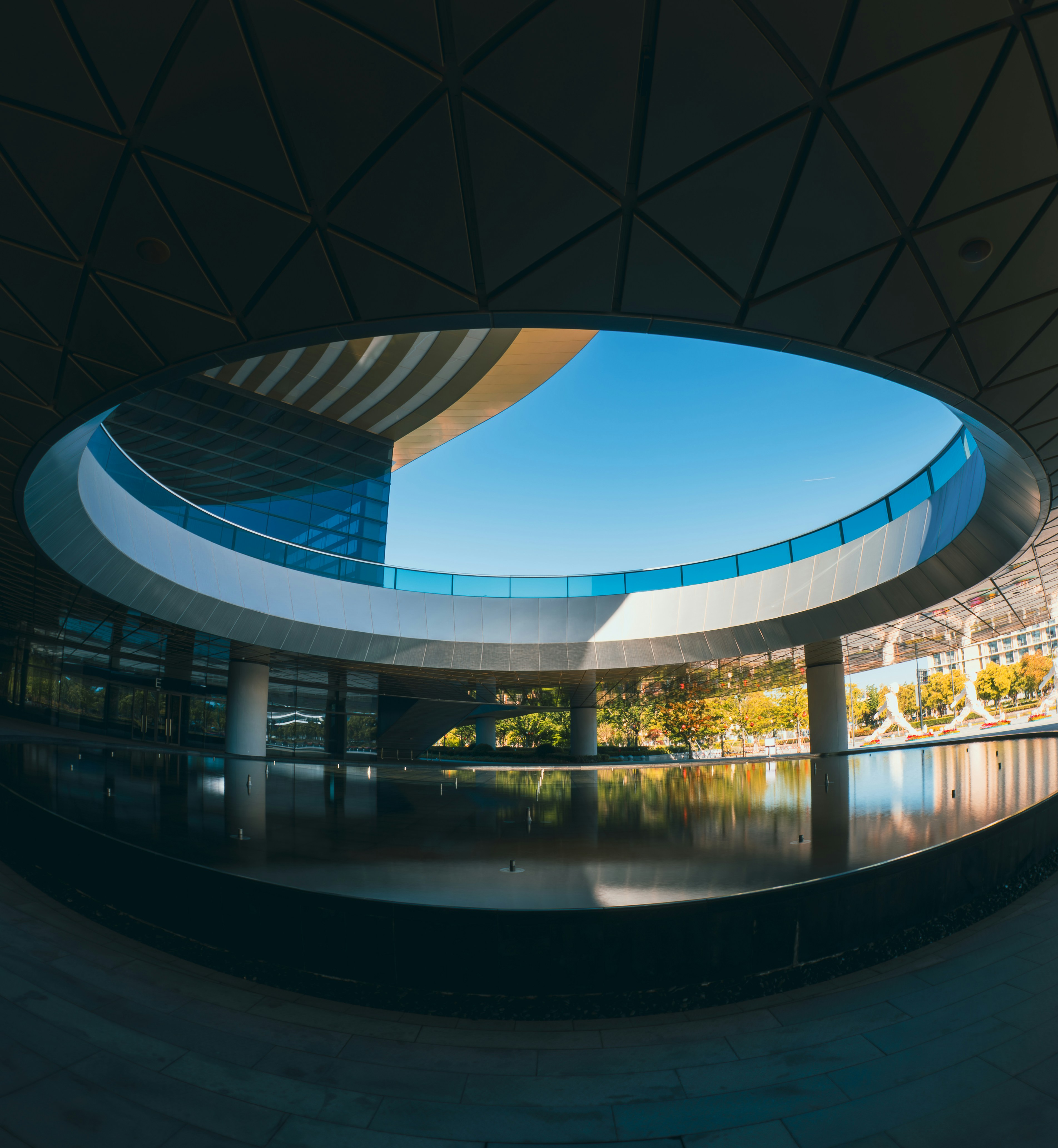 Circular Sky Ring: A Modern Atrium Framed by Glass and Water