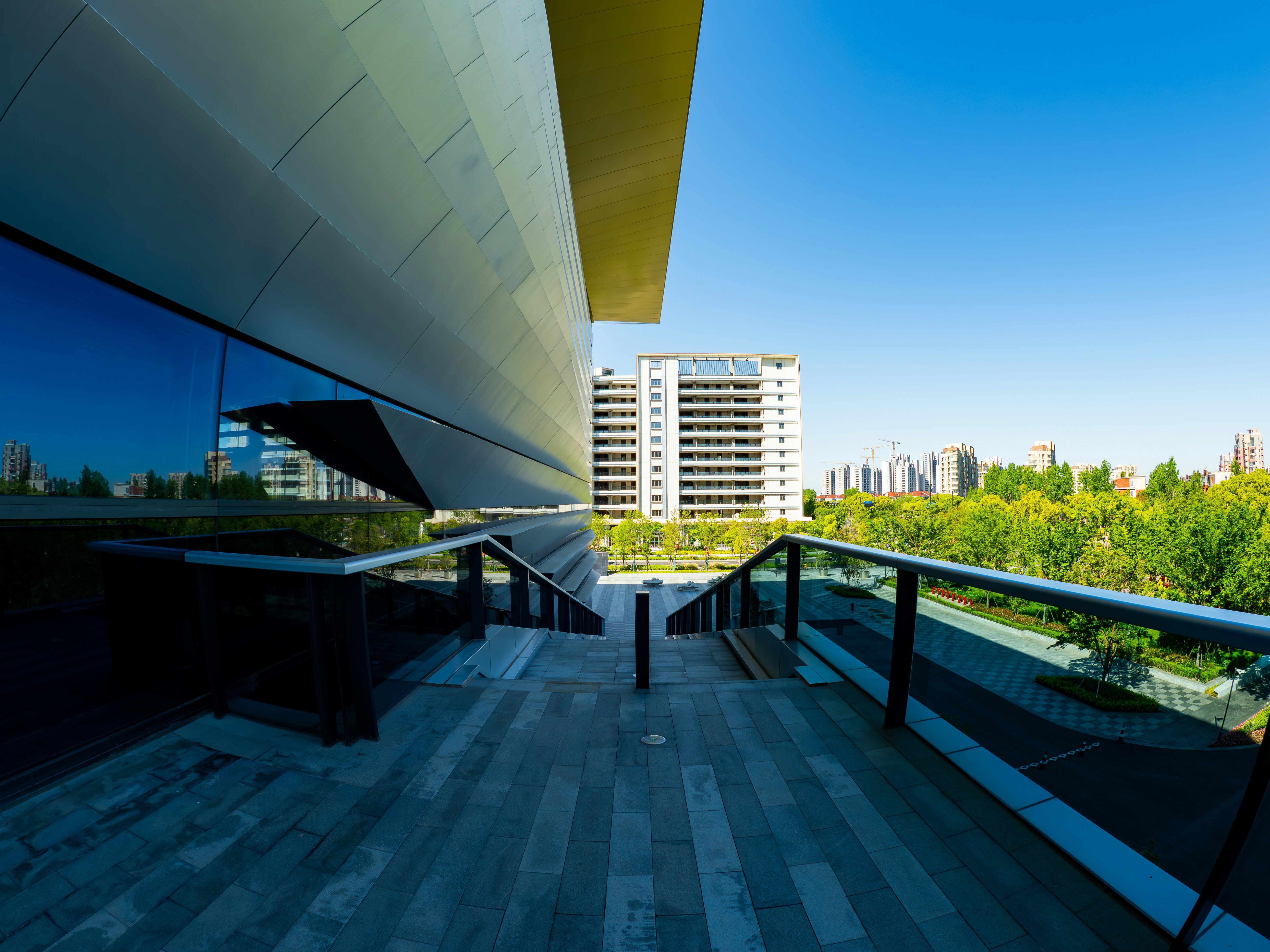 Converging Corridor: Glassed Terrace Framing Urban Light