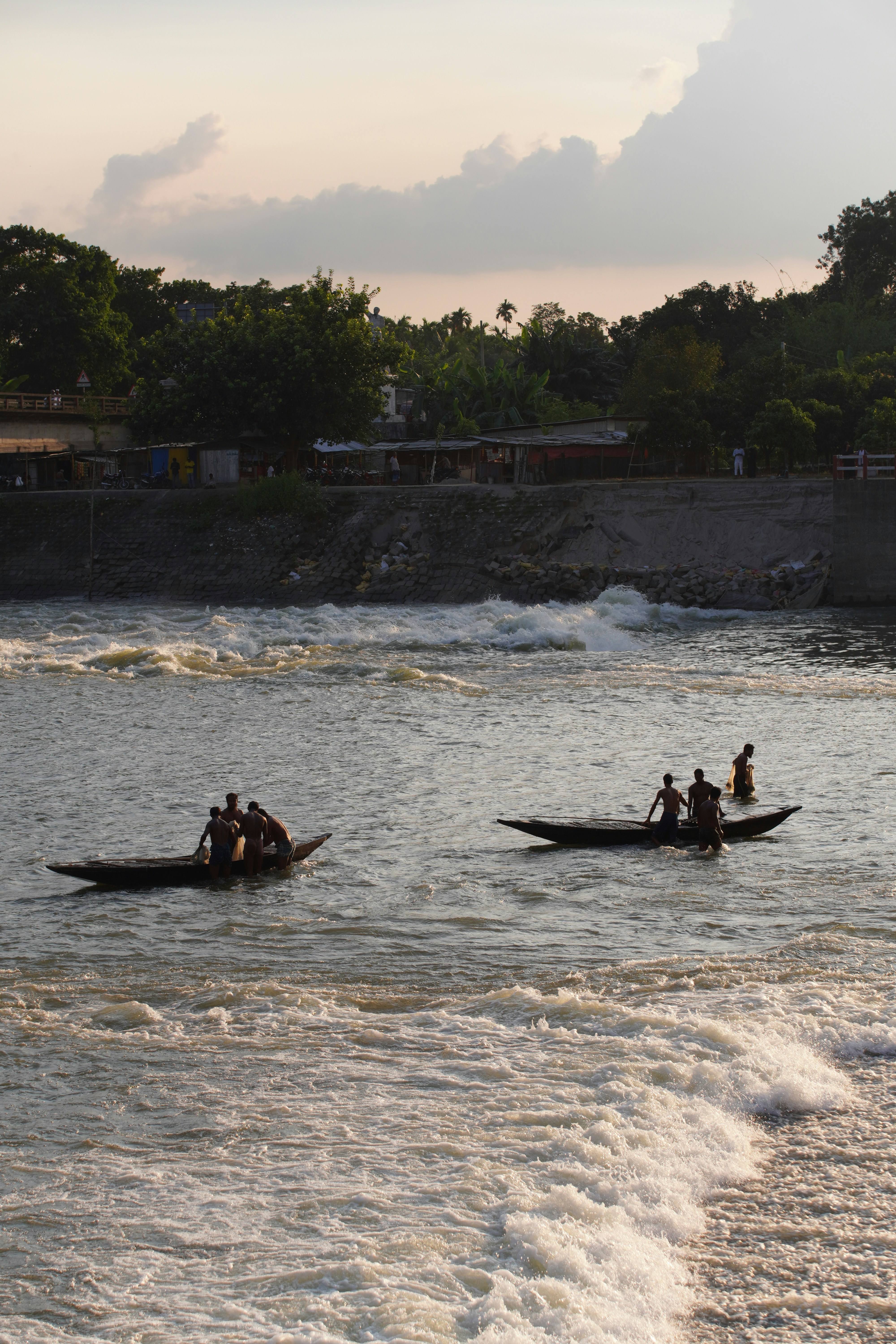 Riverside Fishermen: Two Boats Carring Hands Across Dusk