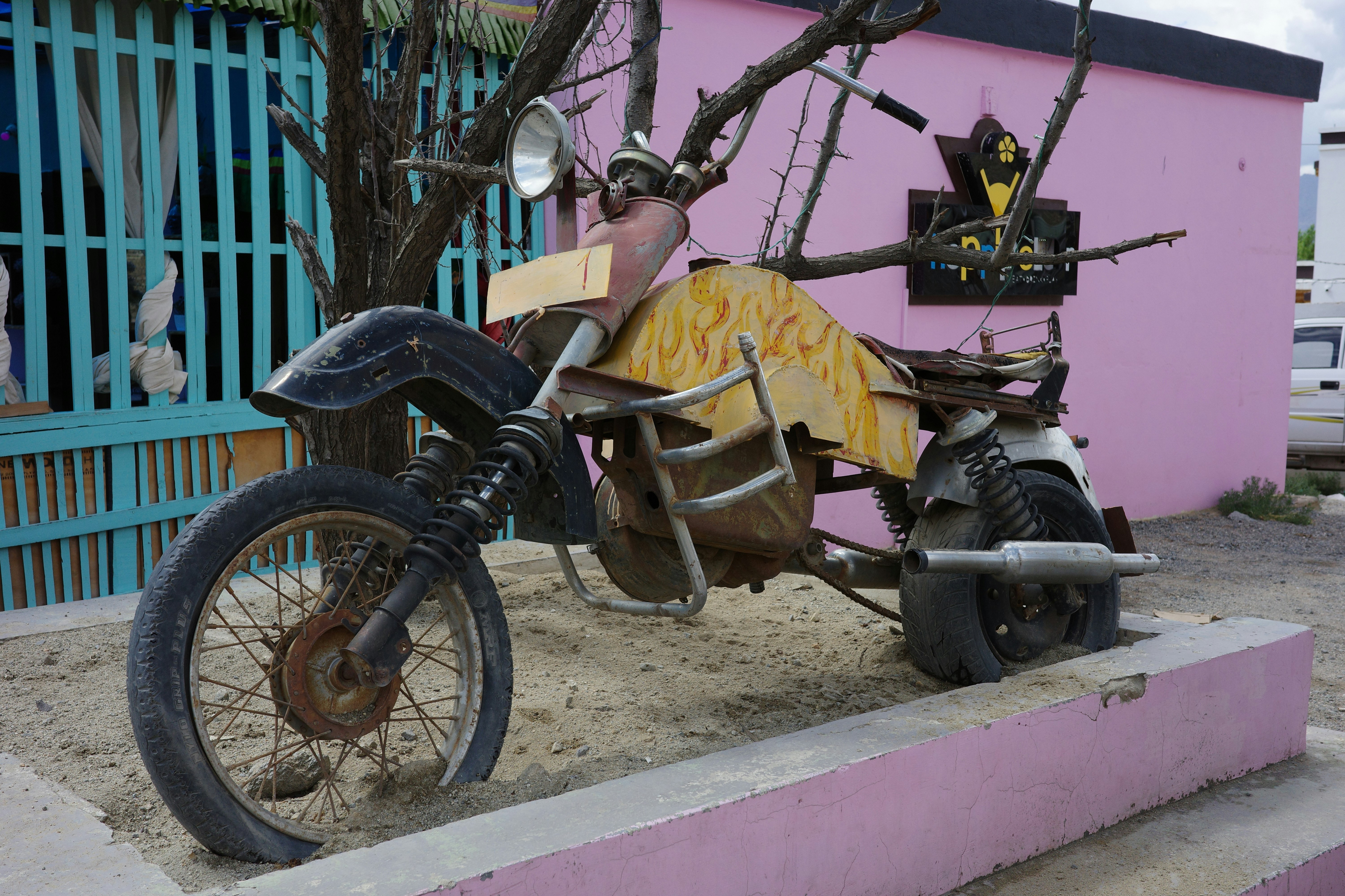 Dusty Dream Machine: A Whimsical Retrofit Quietly Rests by a Pink Wall