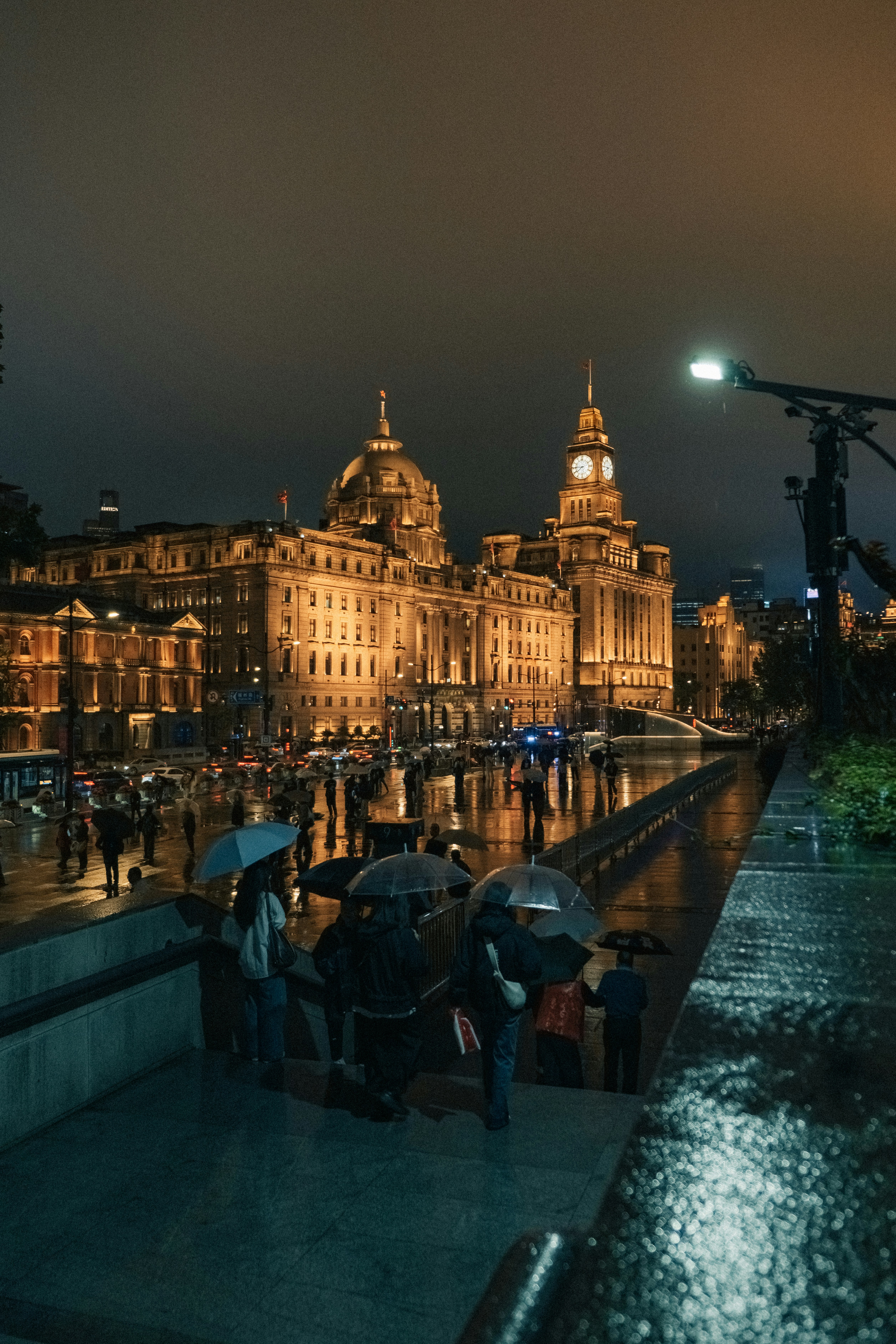 Golden Hour at the Bund: Night Lights Reflect on Wet Promenade