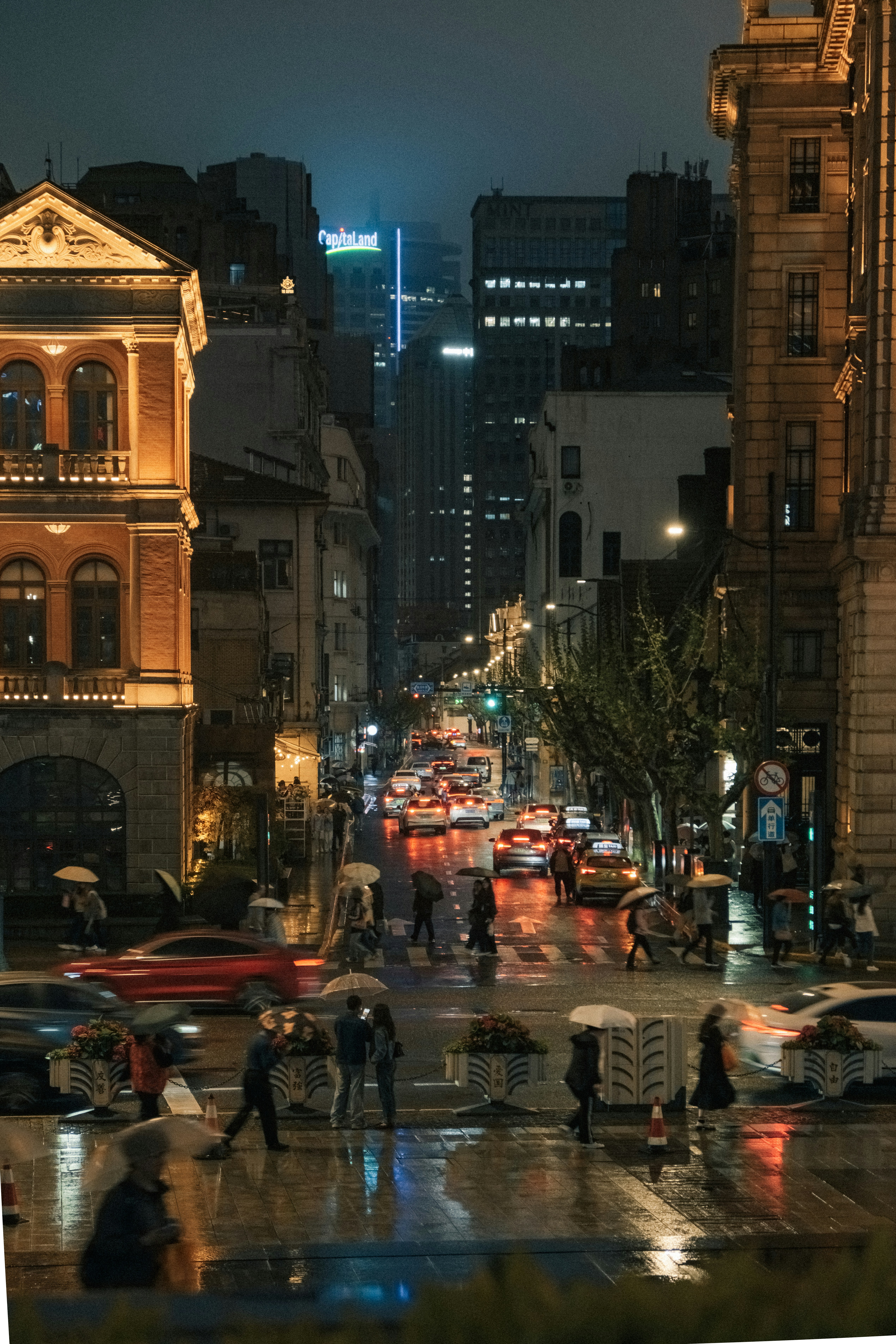 Street Pulse: Night Rain Illuminates a City Crossing