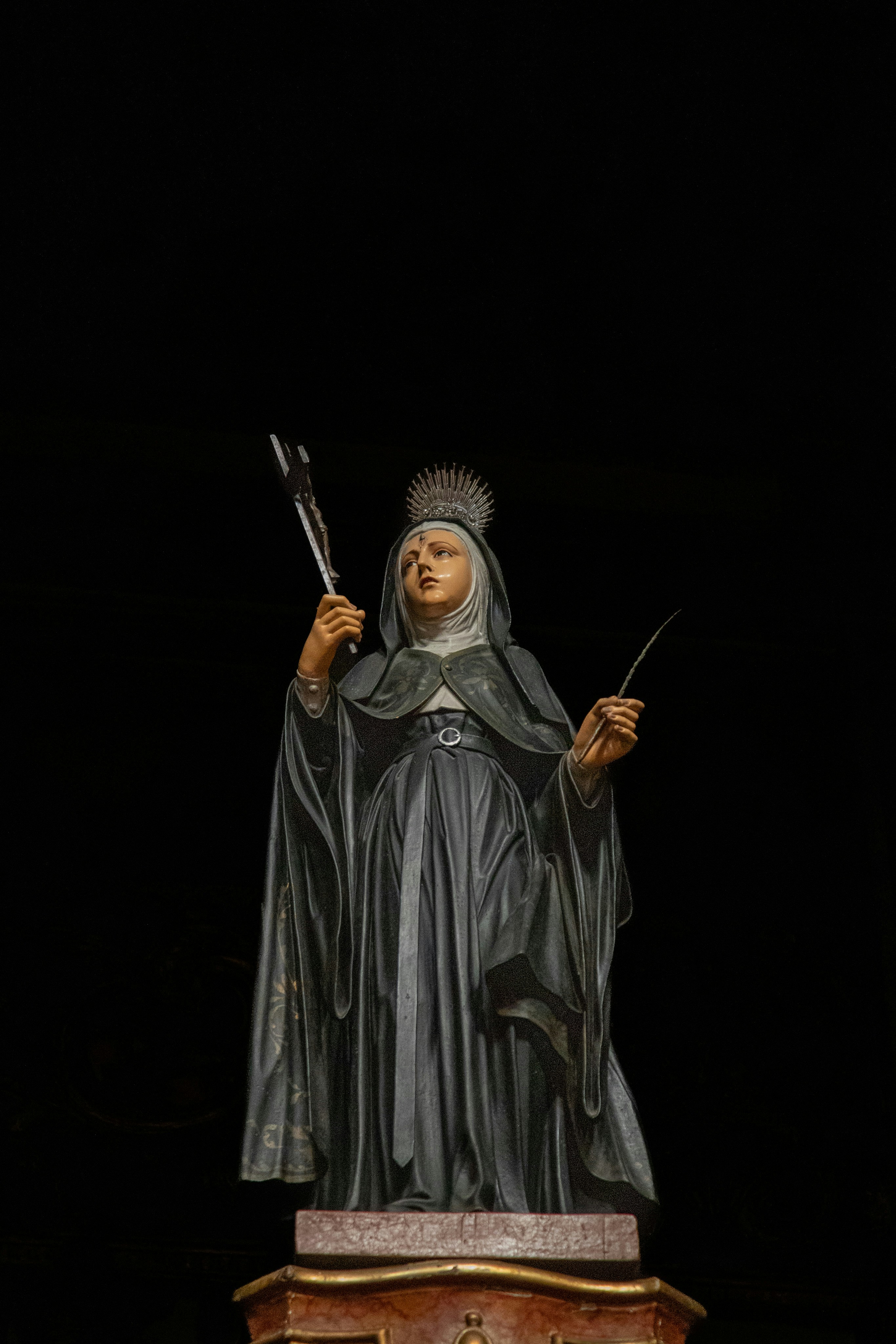 A Nun of Night: Statue Elevates the Vigil with Torch and Quill