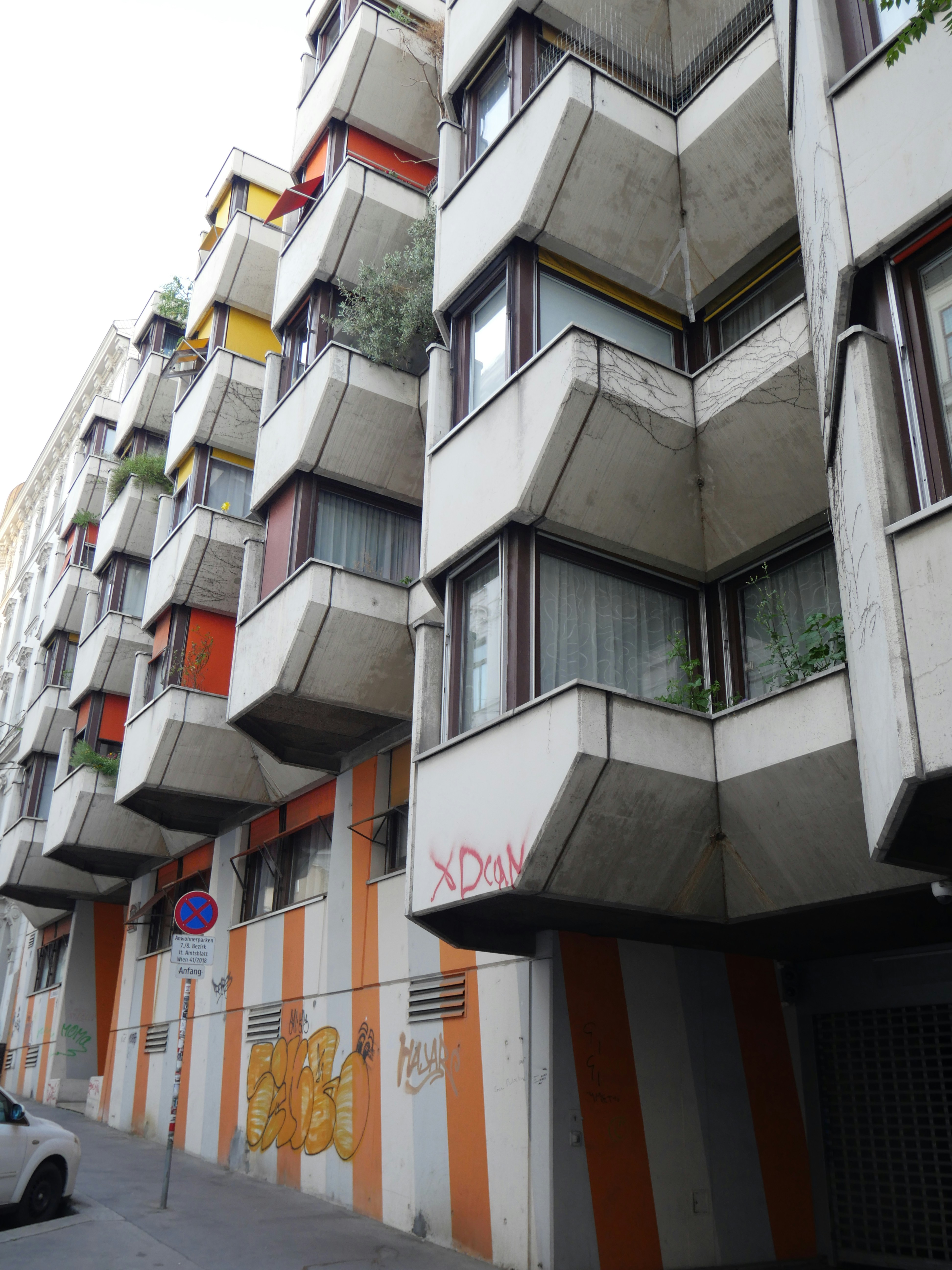 Concrete Bauhaus Echo: Angular Balconies Clad in Color Stripes