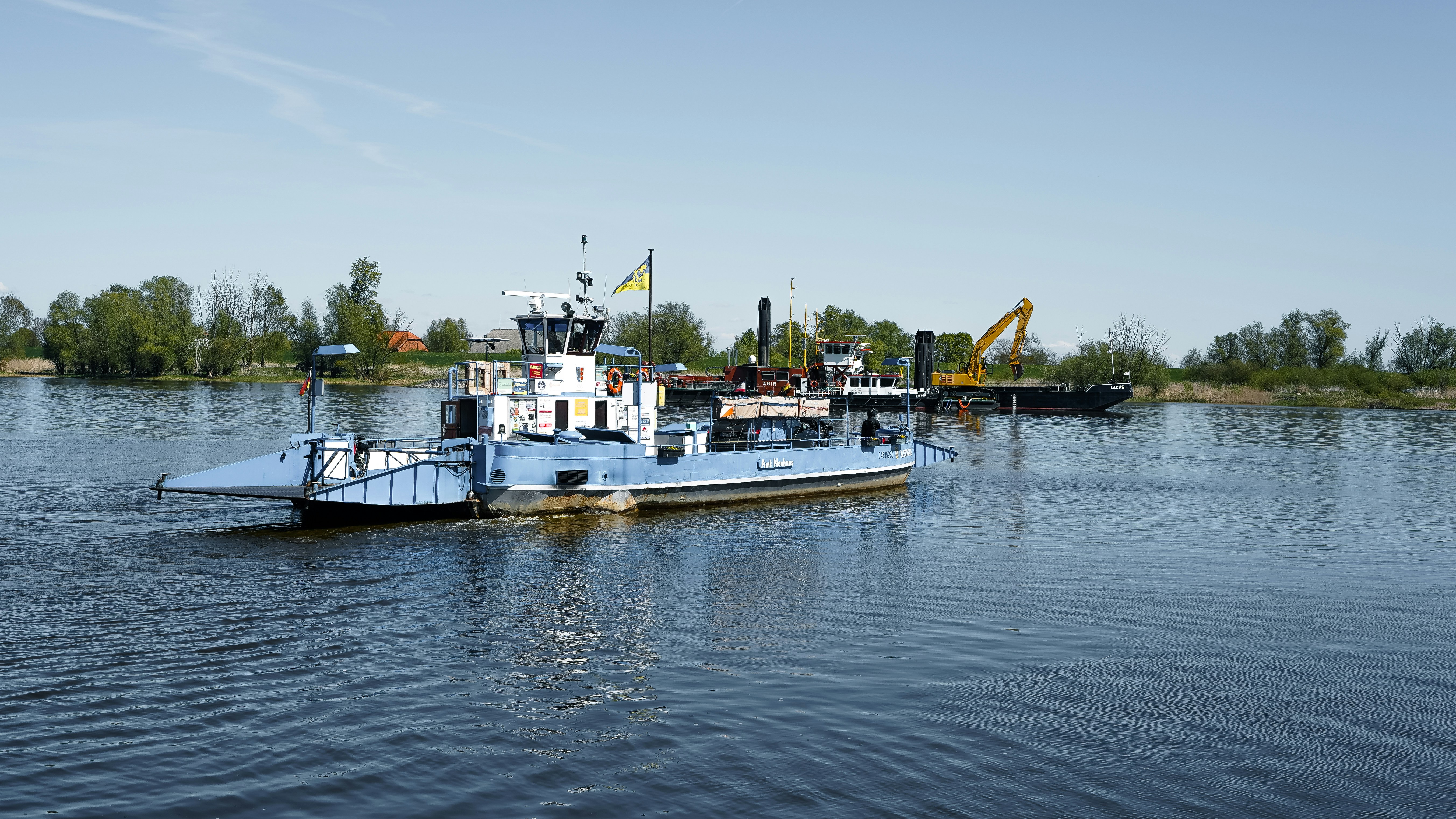 Blue Tugboat Drifting through Calm Riverside Locks