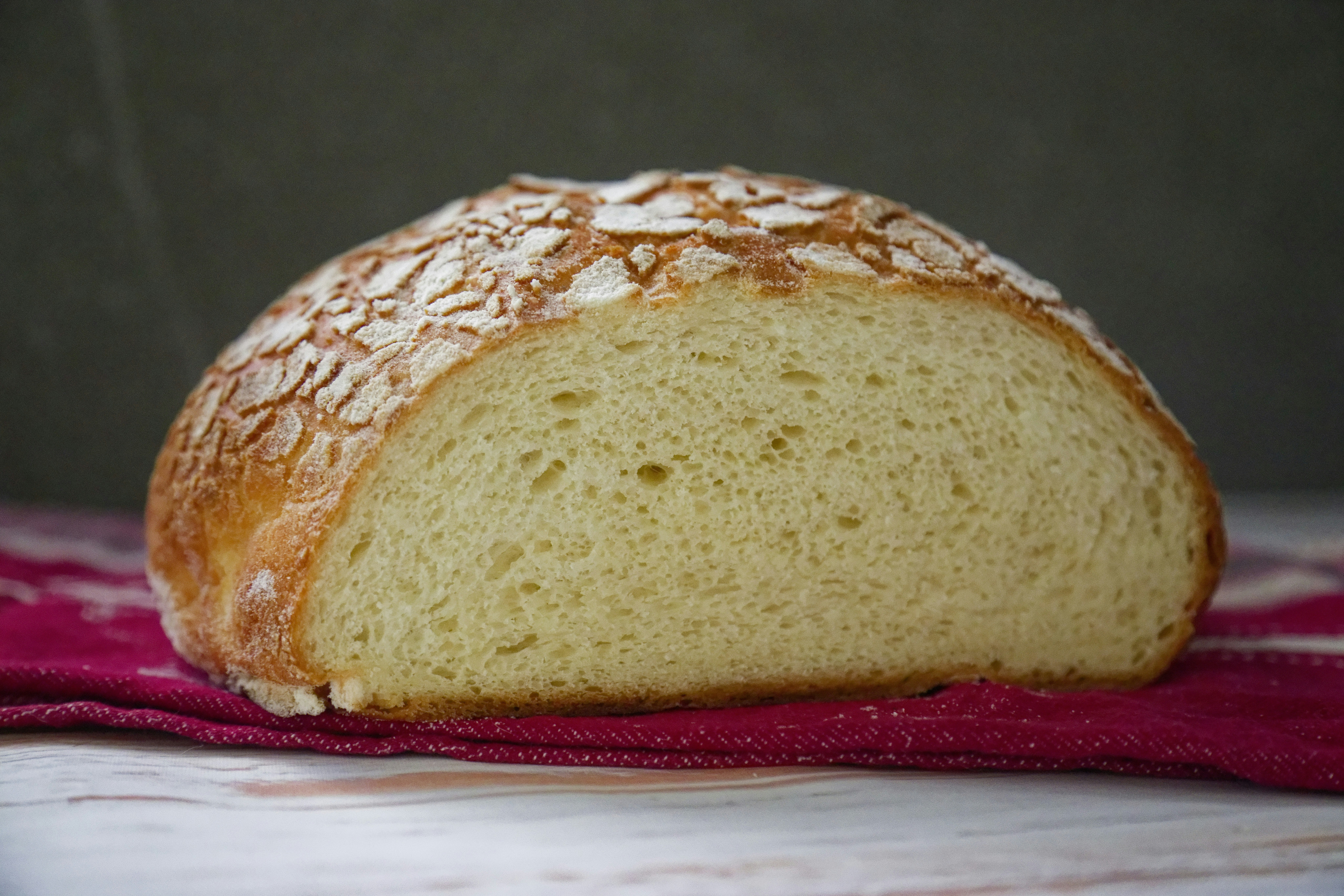 Crust with character: a loaf of crusty white bread resting on a red cloth