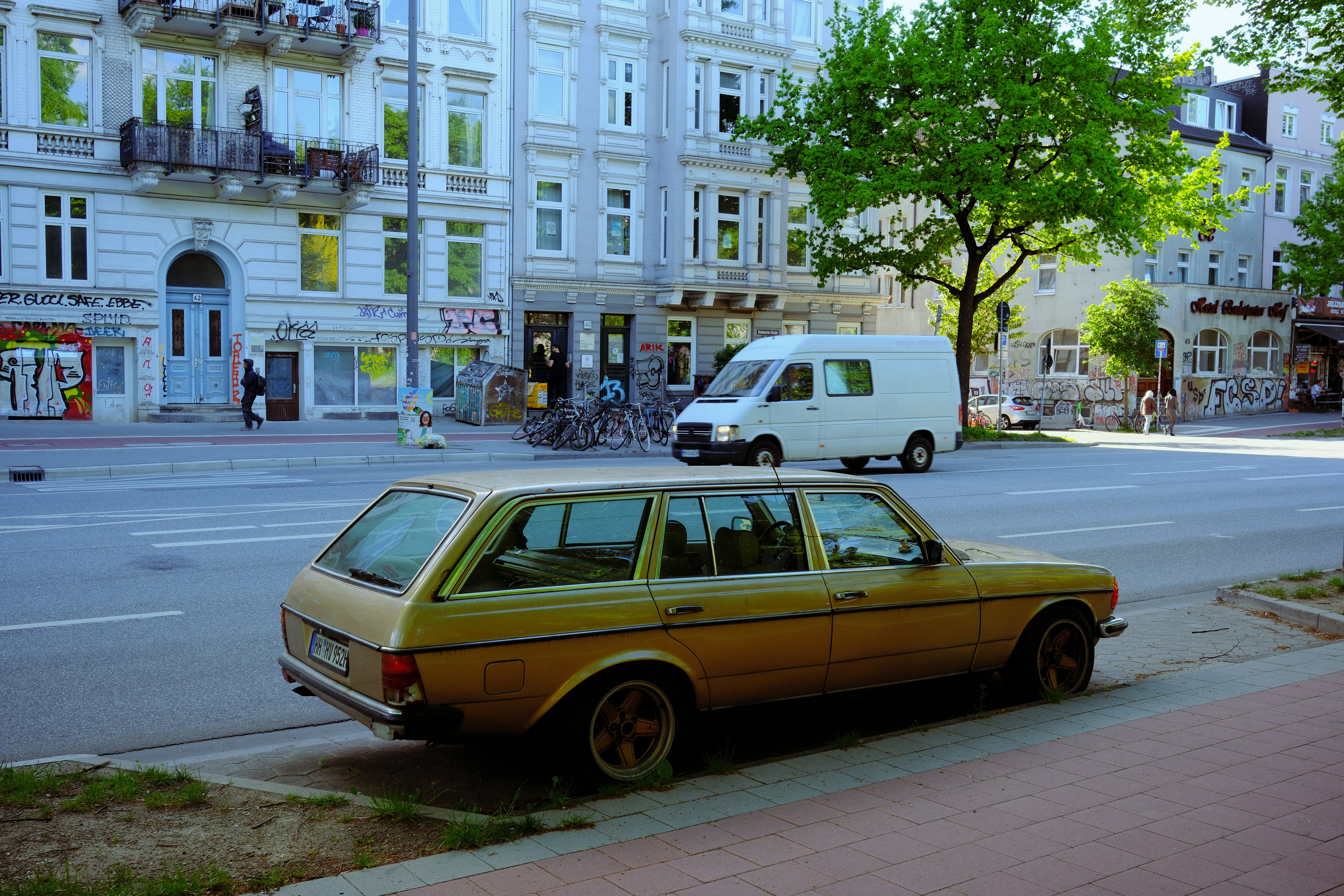 Orange vintage station wagon meets city street panorama