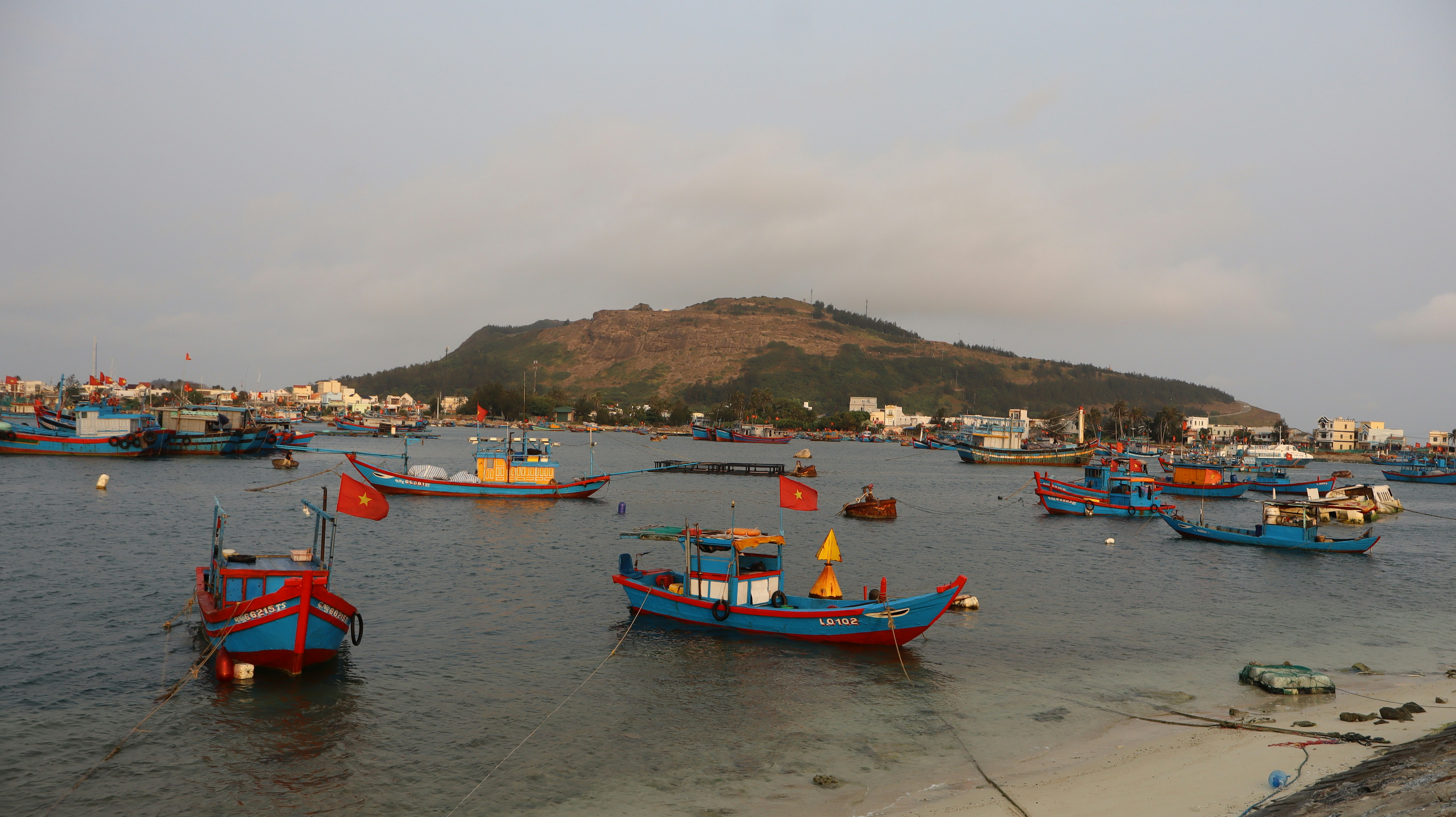 Harbor Mosaic: Colorful Boats Framing a Coastal Town