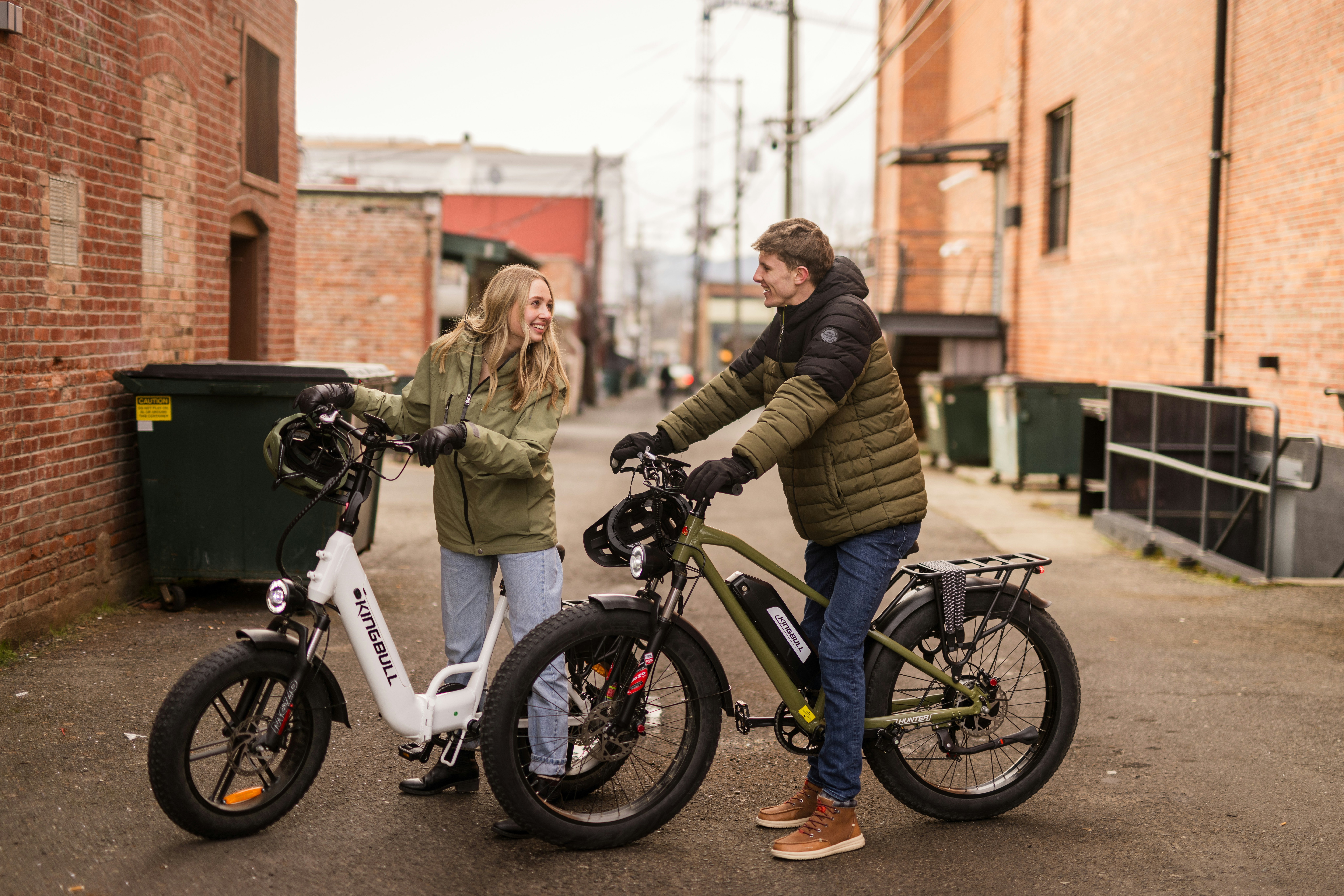 Two Friends with E-bikes in an Urban Alleyway