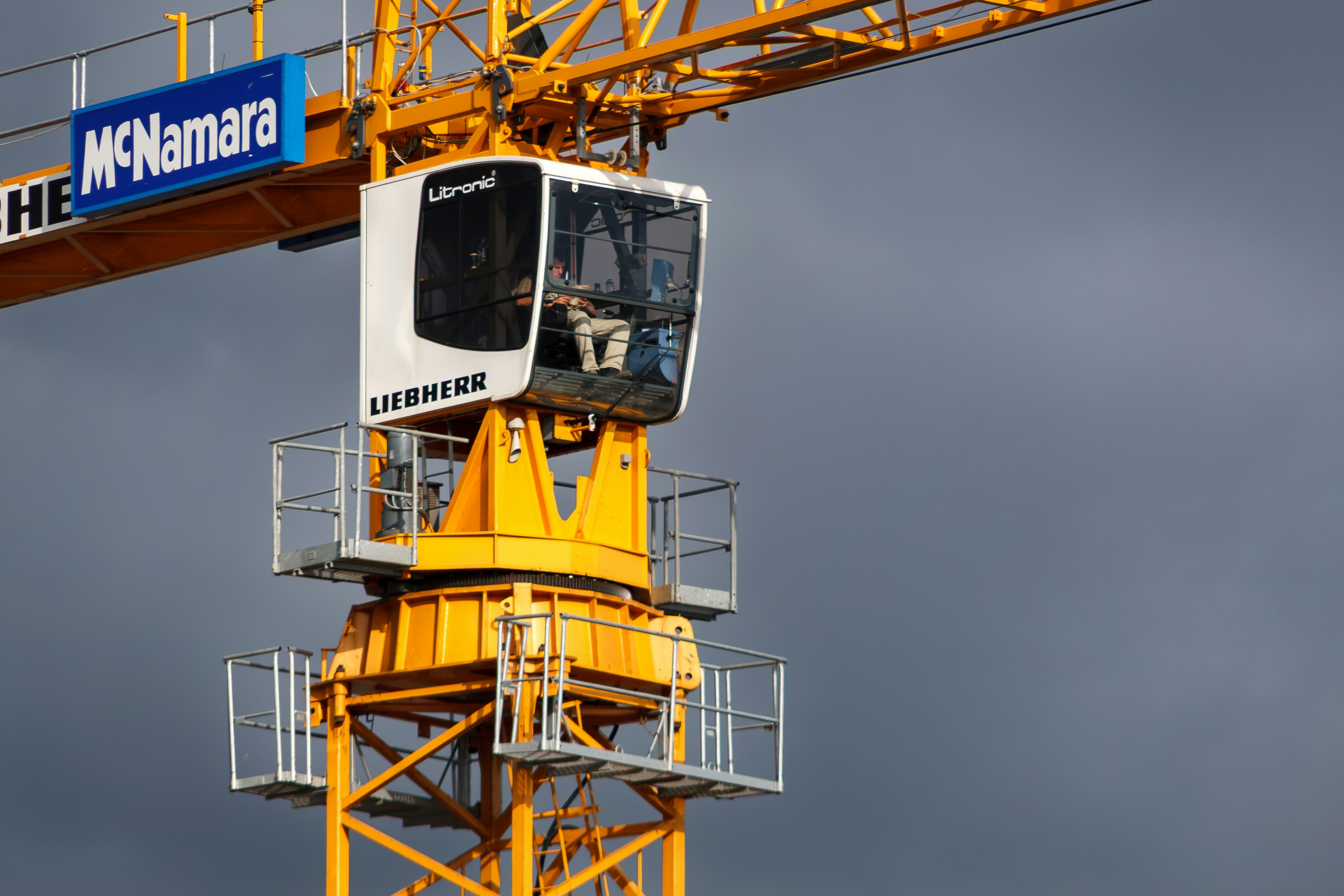 Looming Crane Cab Overlooking a Steel Framework