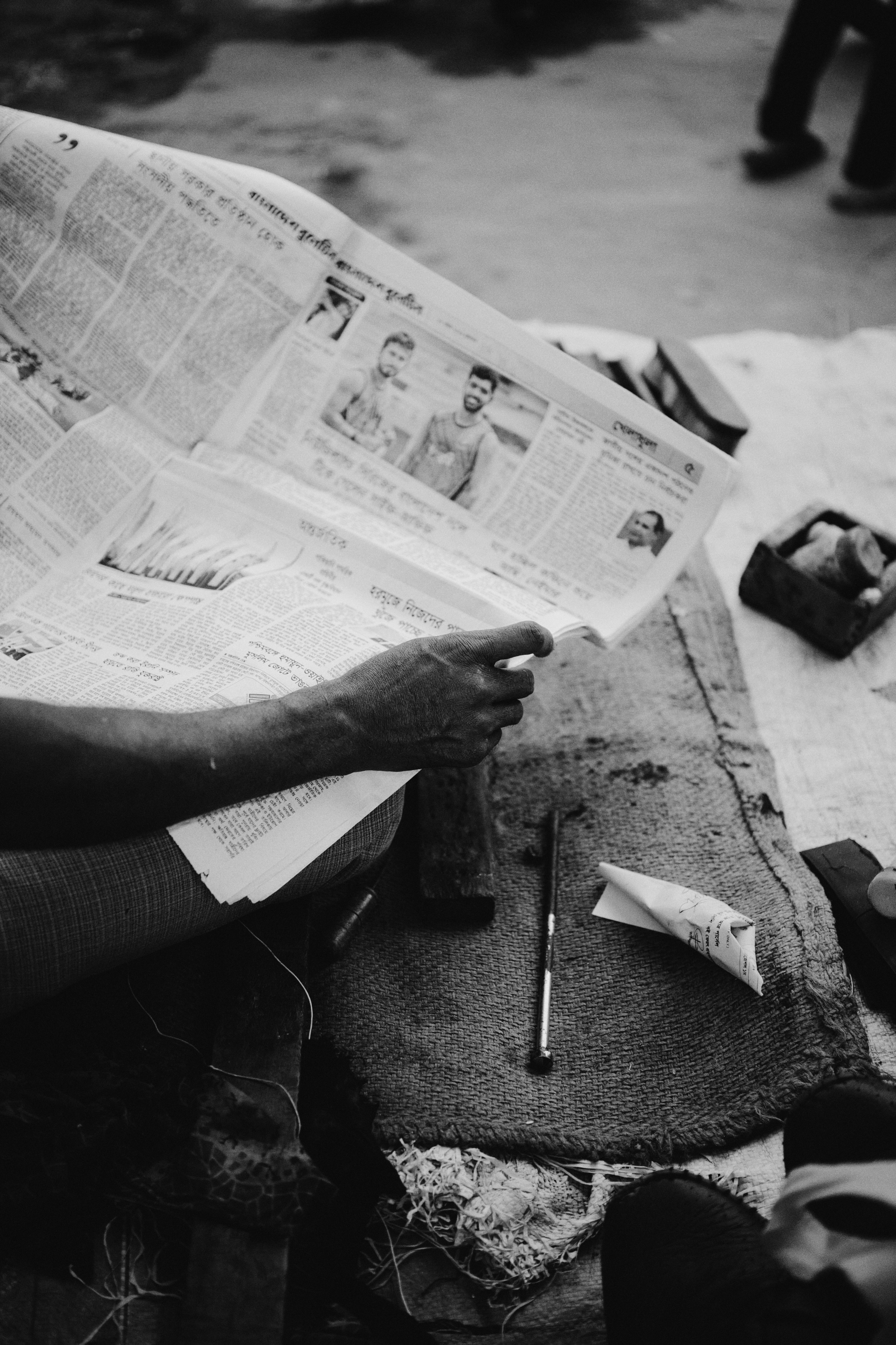 Reading the Daily: A Street Vendor with a Newspaper