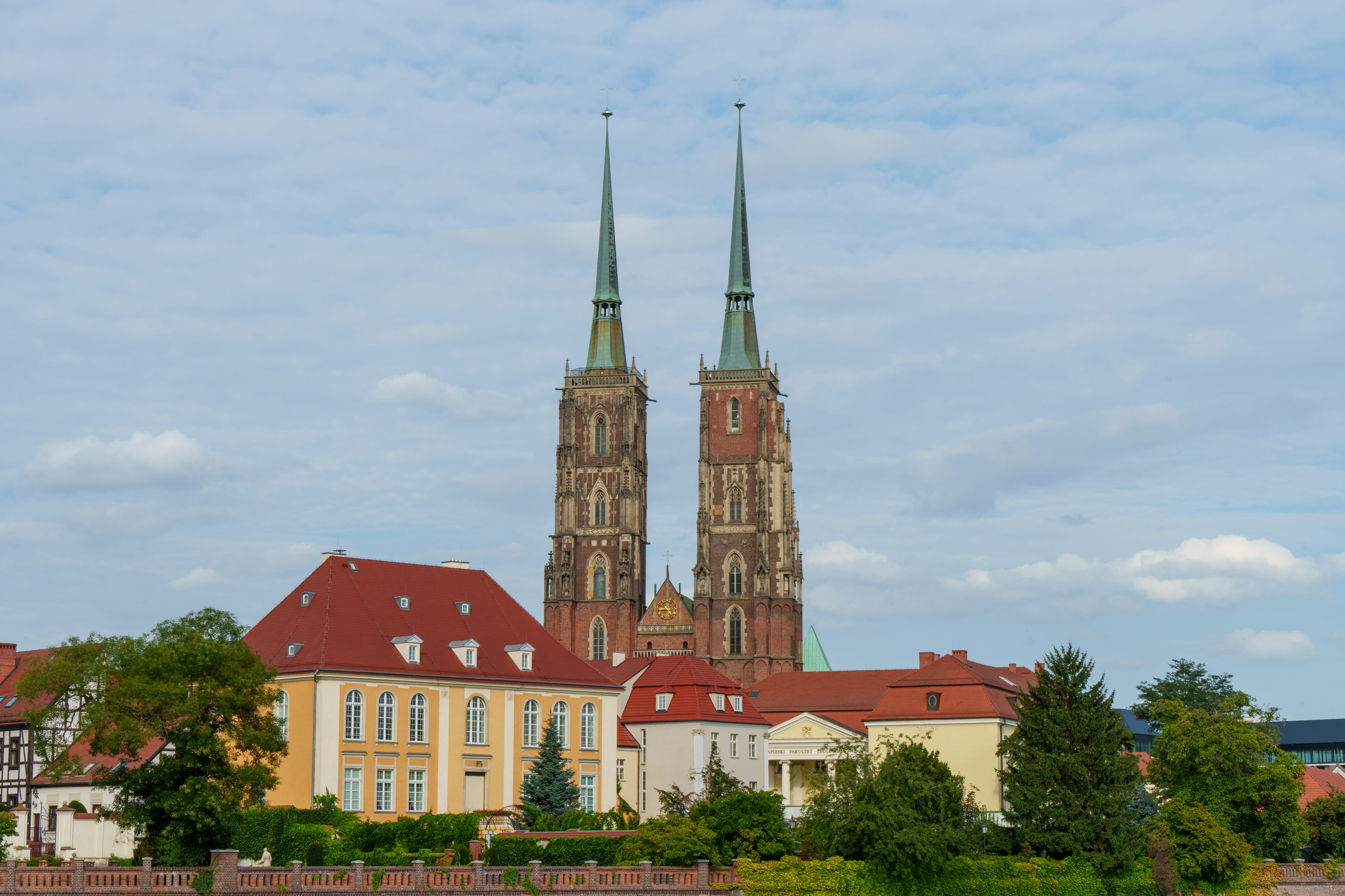 Twin Spires Rising Above a Colorful European Riverside
