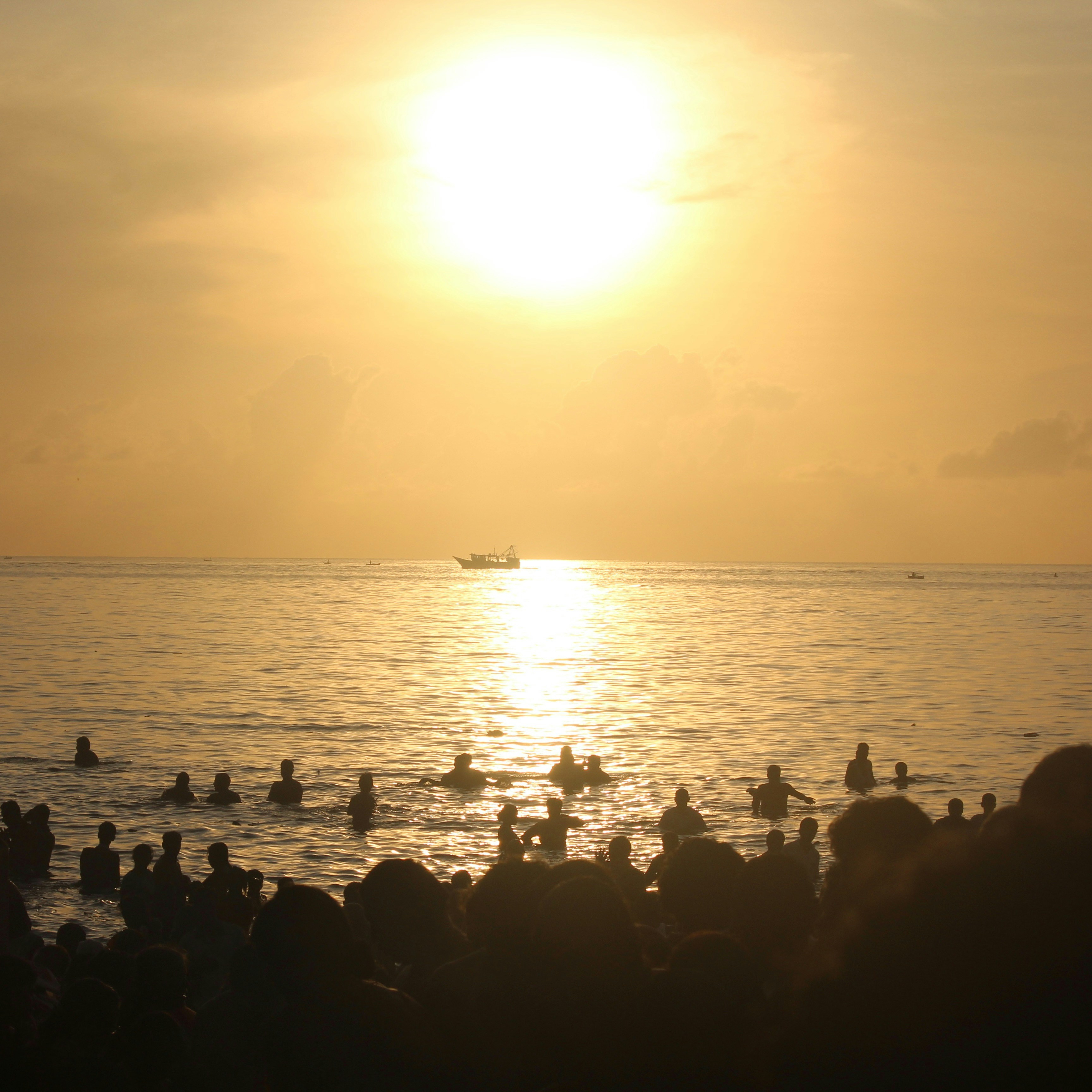 Golden Tempest: A Silhouette of People at Dusk on a Calm Sea