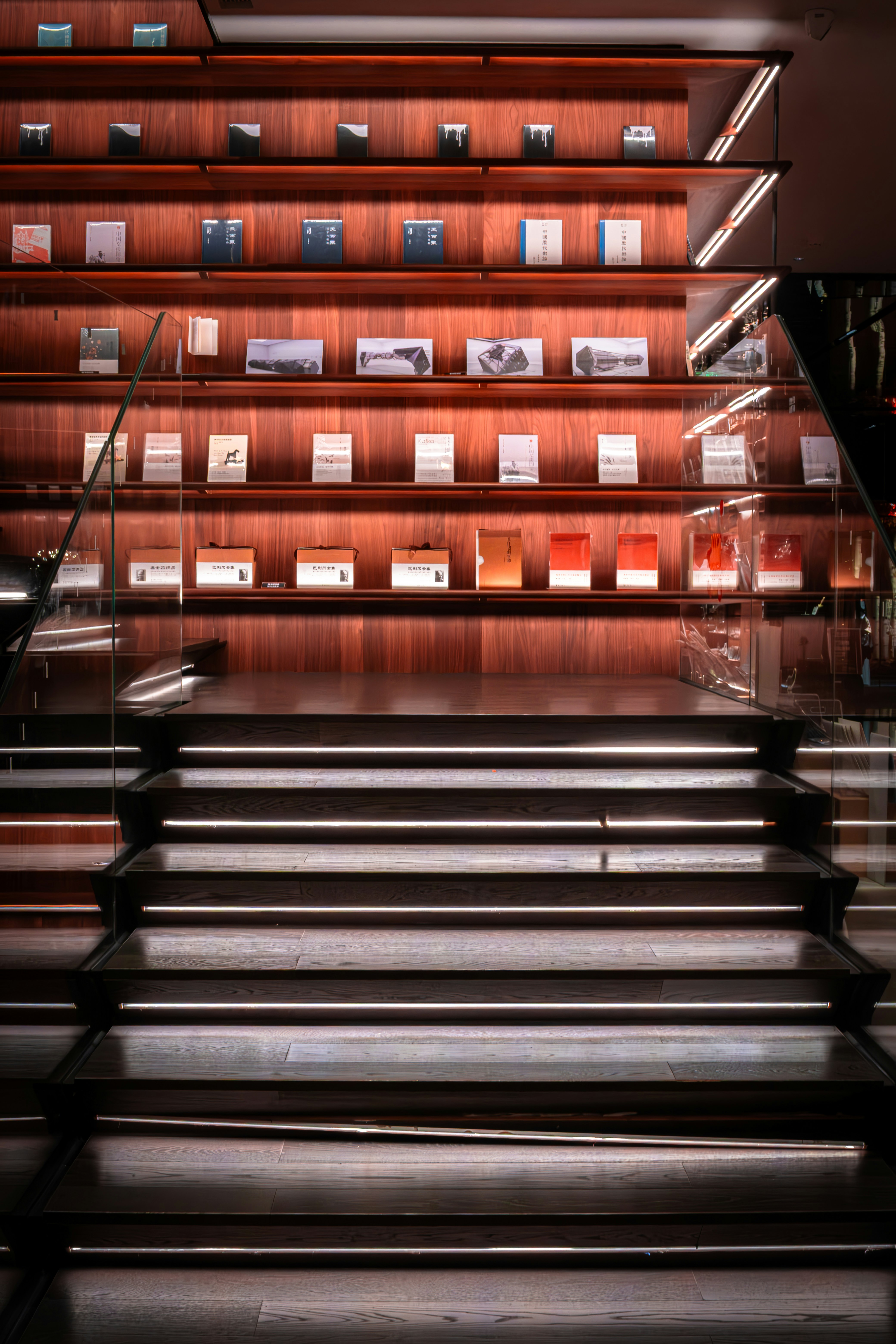 Warm Library Staircase: Backlit Shelves of Booklets and Cards