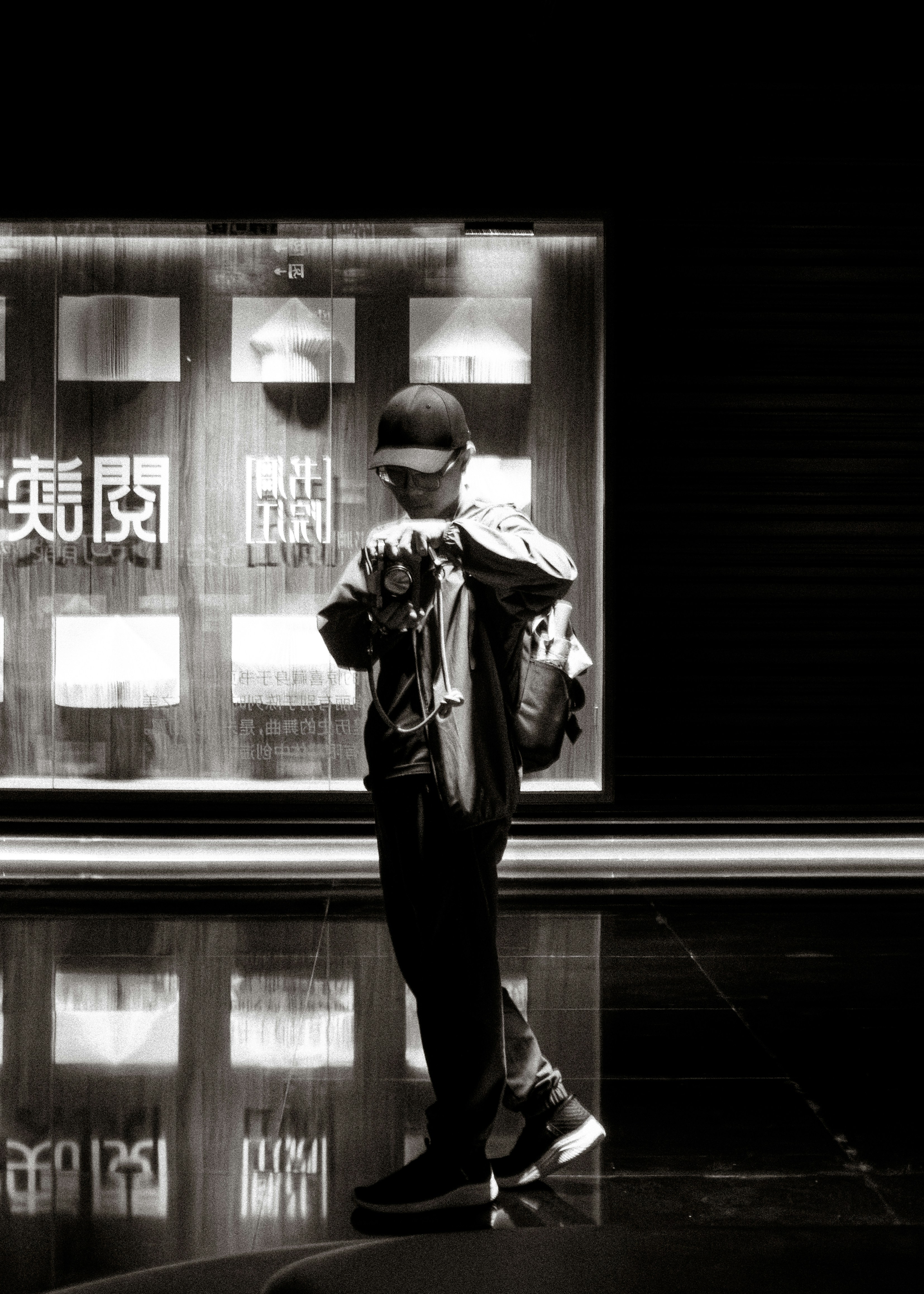 Shadowed Aperture: A Street Photographer in a Quiet Metro Moment