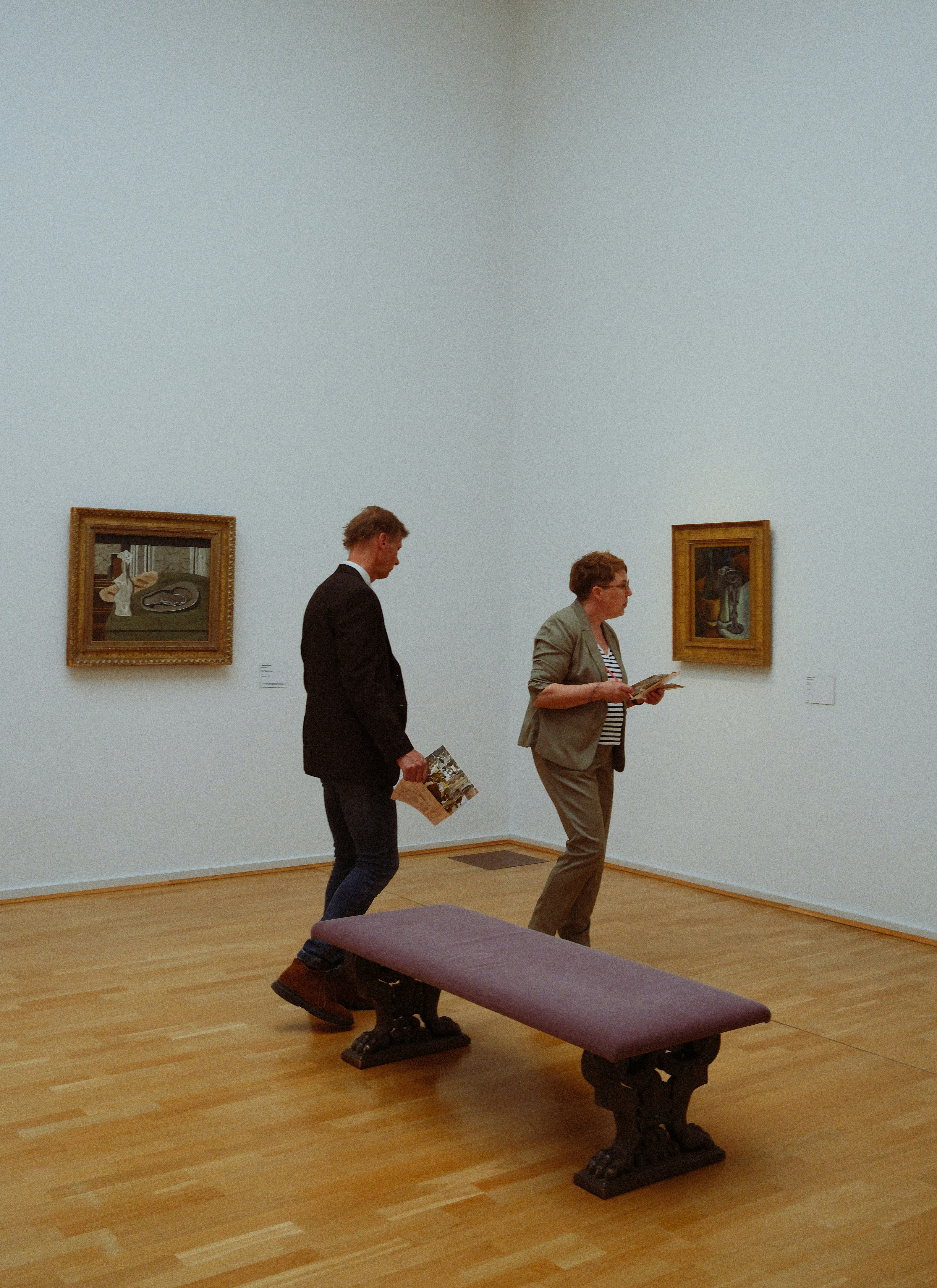 Mid-Gallery Pause: Two Visitors Examine a Painting