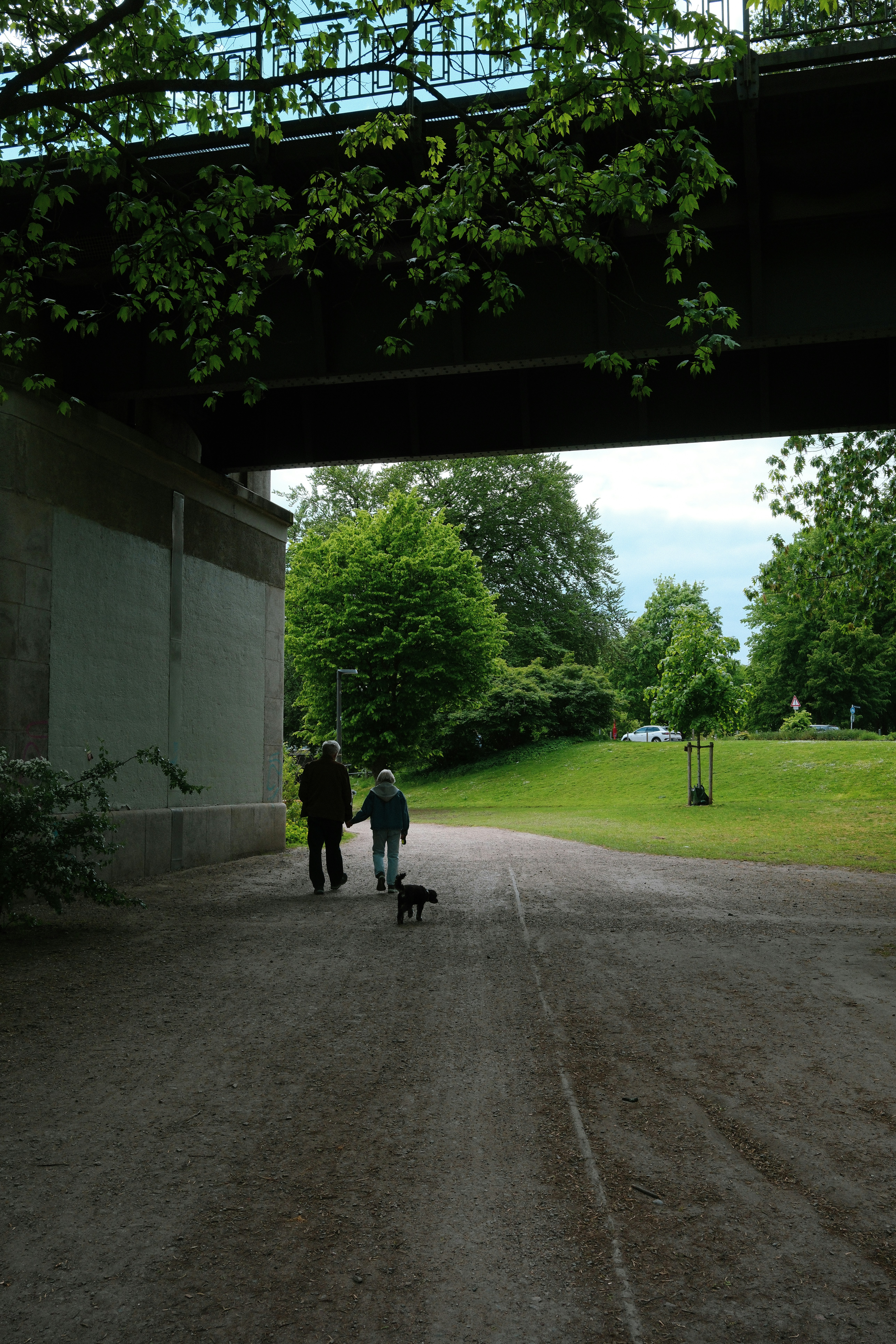 A Quiet Stroll Beneath an Arched Bridge