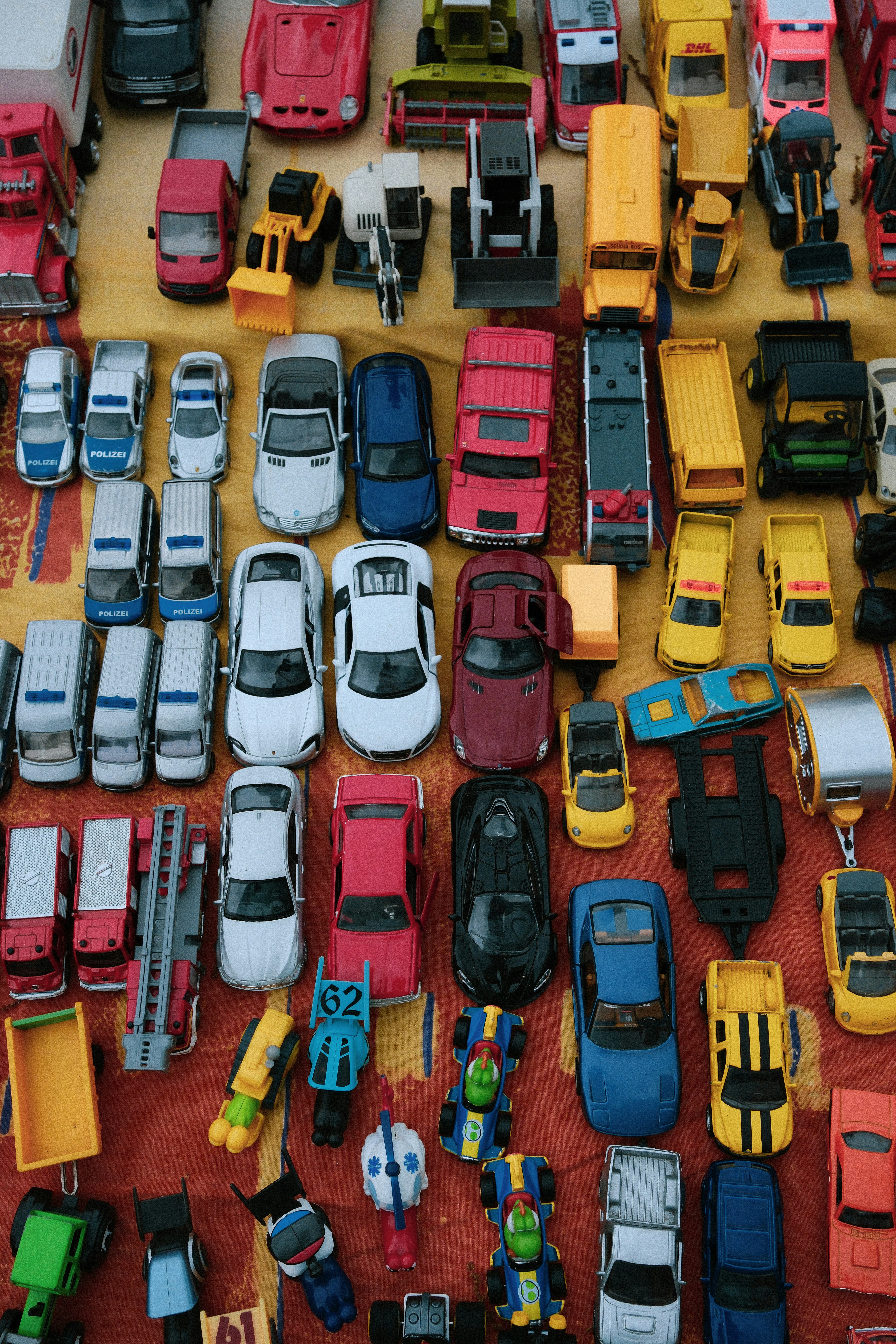Aerial Toy Lot: City of Mini Vehicles Parading in Color