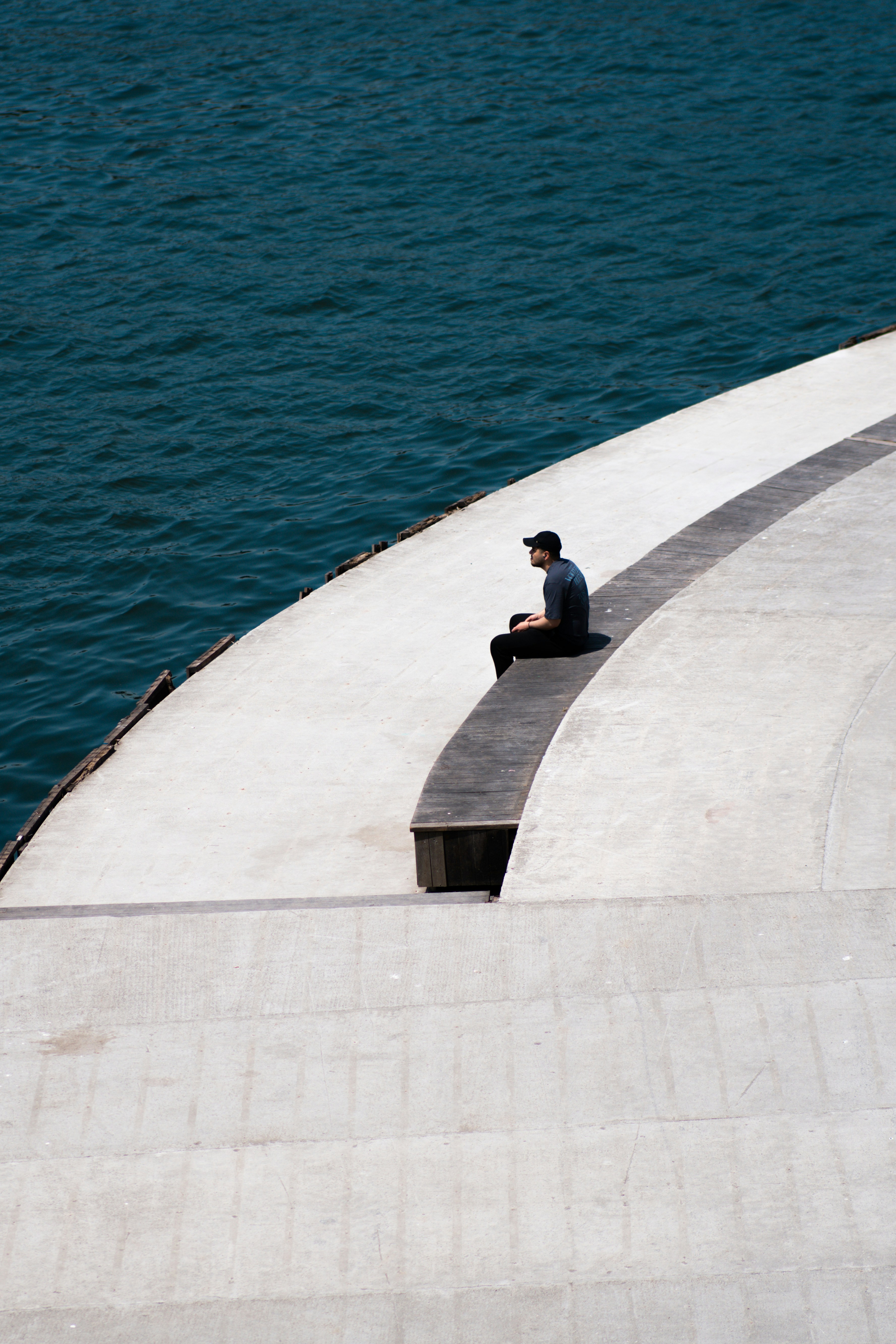 Solitary Moment on a Curved Concrete Promenade